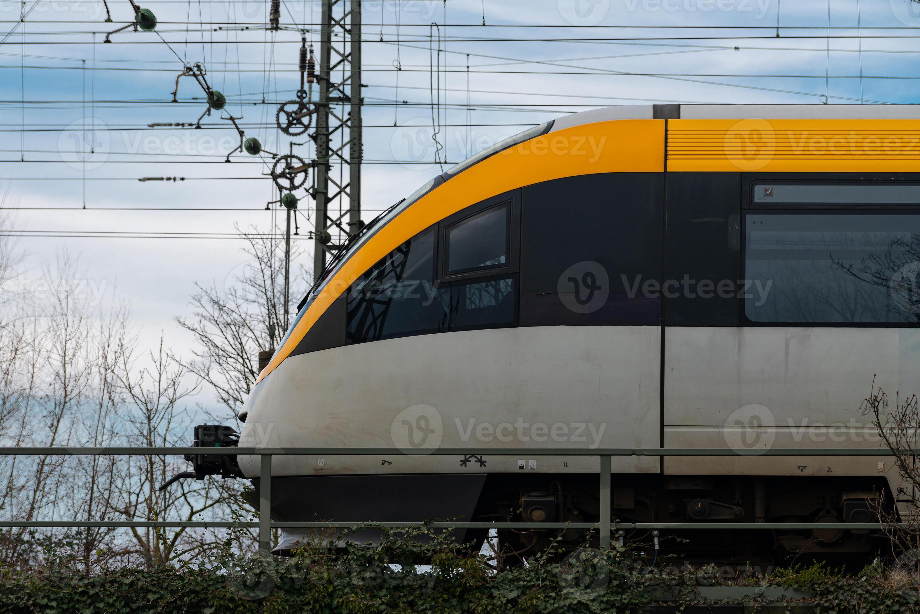 Modern train gliding past electric pylons on a cloudy day 55793903 Stock Photo at Vecteezy