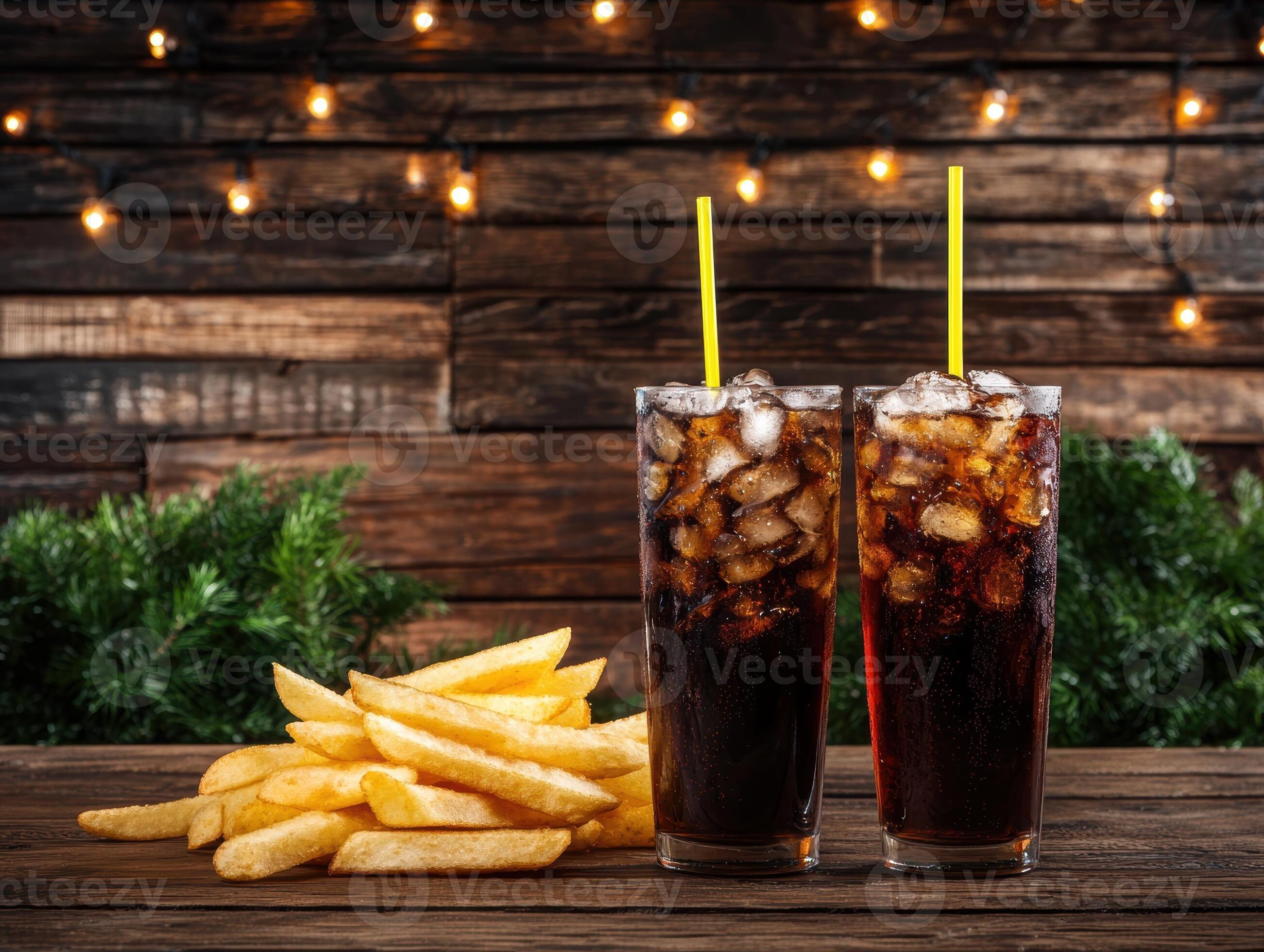 Two glasses of cola with ice and fries on a wooden table 55989095 Stock Photo at Vecteezy