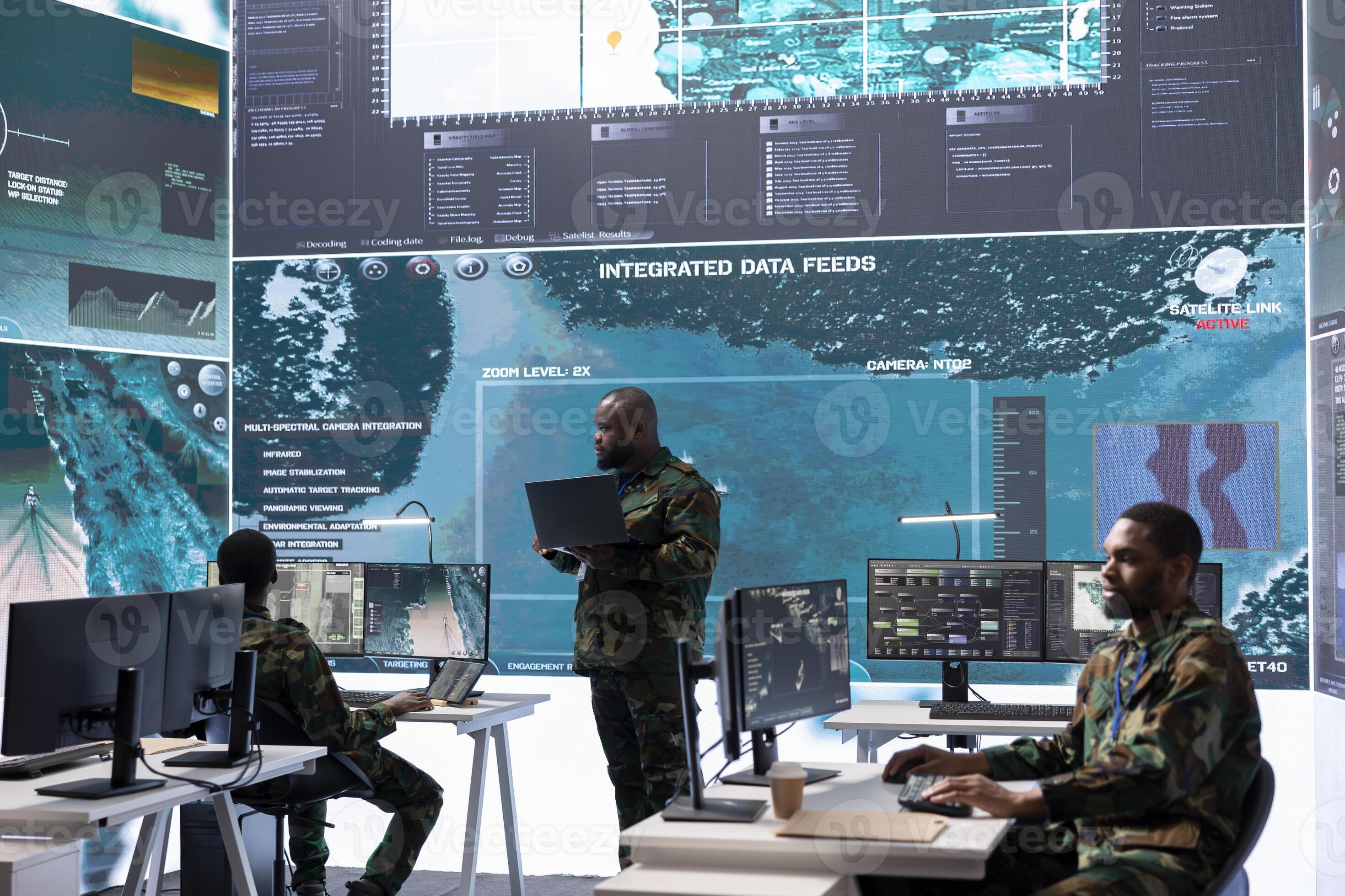 Army professionals in a command center oversee satellite data feeds ...