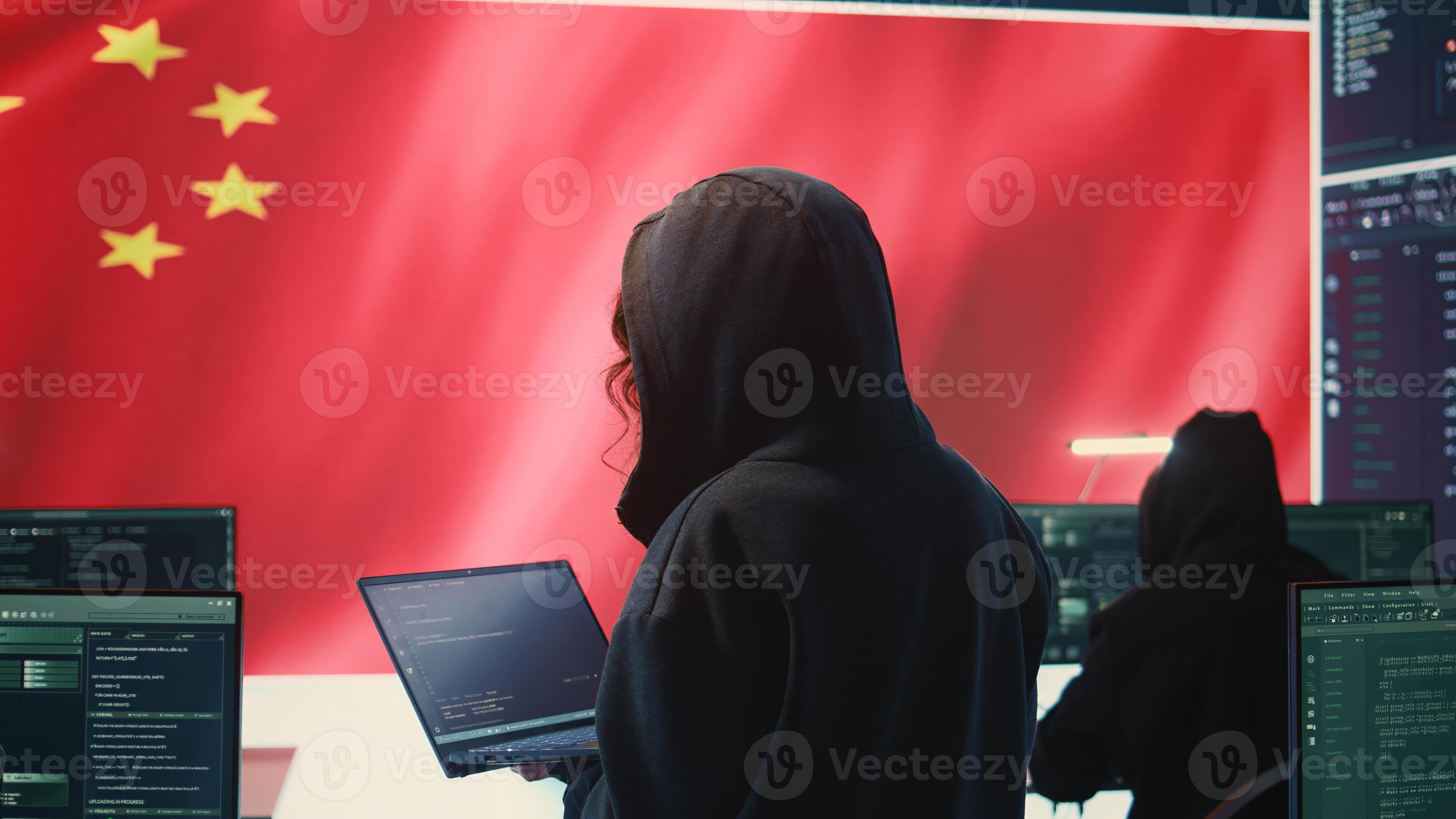 Chinese Hacker Working In Governmental Hacking Room With Chinese Flag On A Big Screen Having