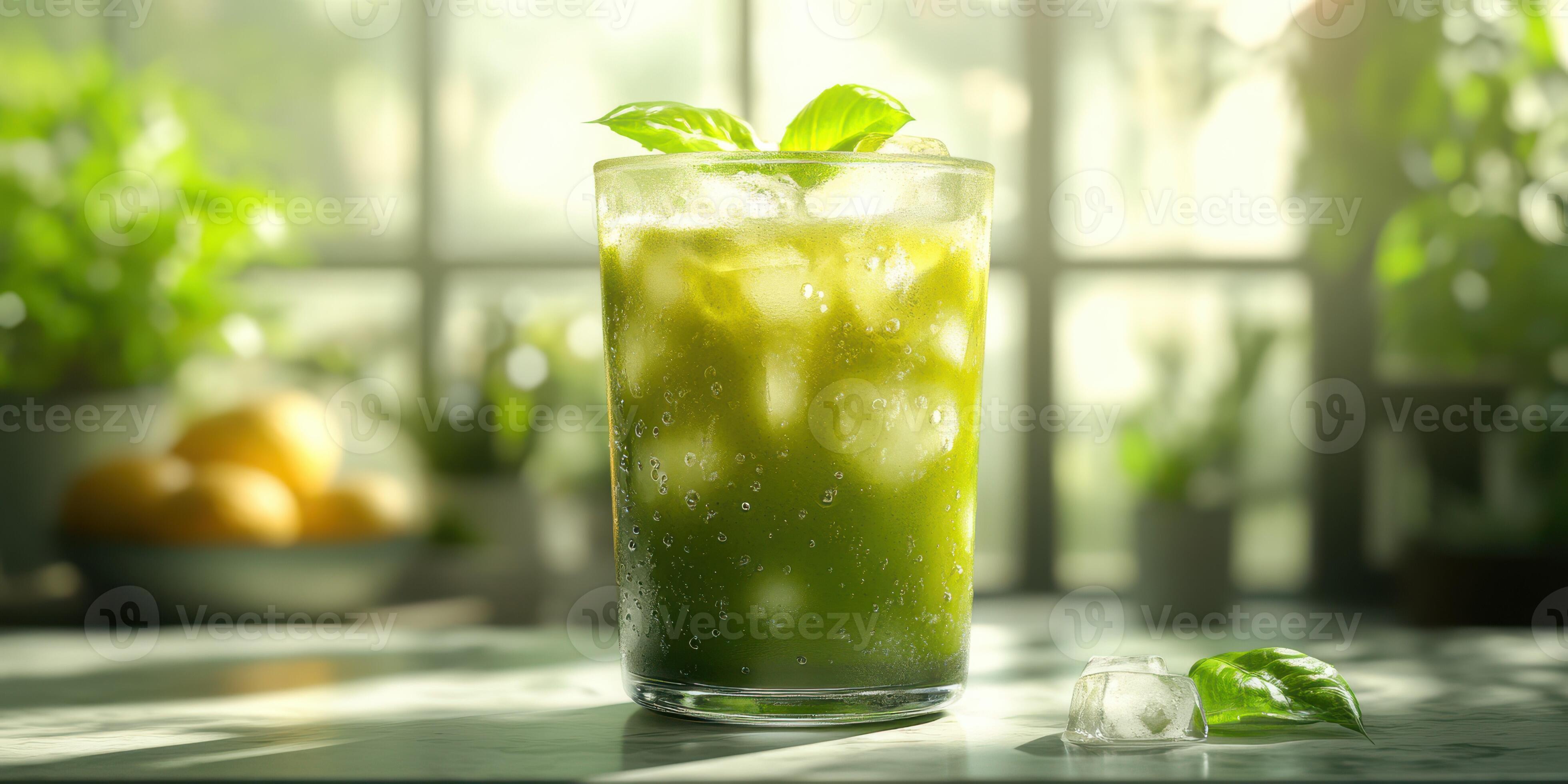 Refreshing green beverage with ice in a sunlit kitchen filled with plants and fruits 56339286 ...