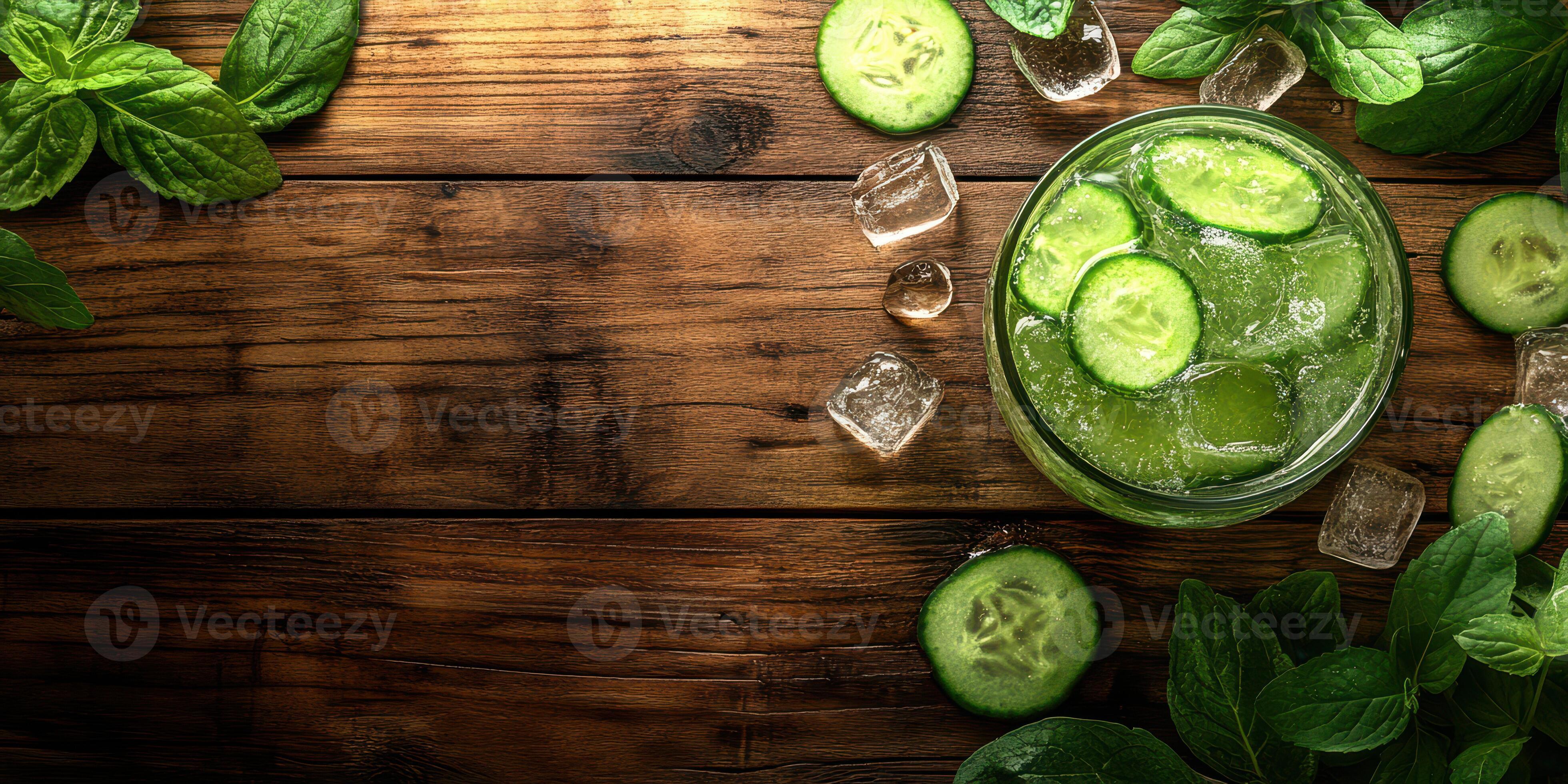 Refreshing cucumber mint drink served in a glass with ice on a rustic wooden table 56348820 ...