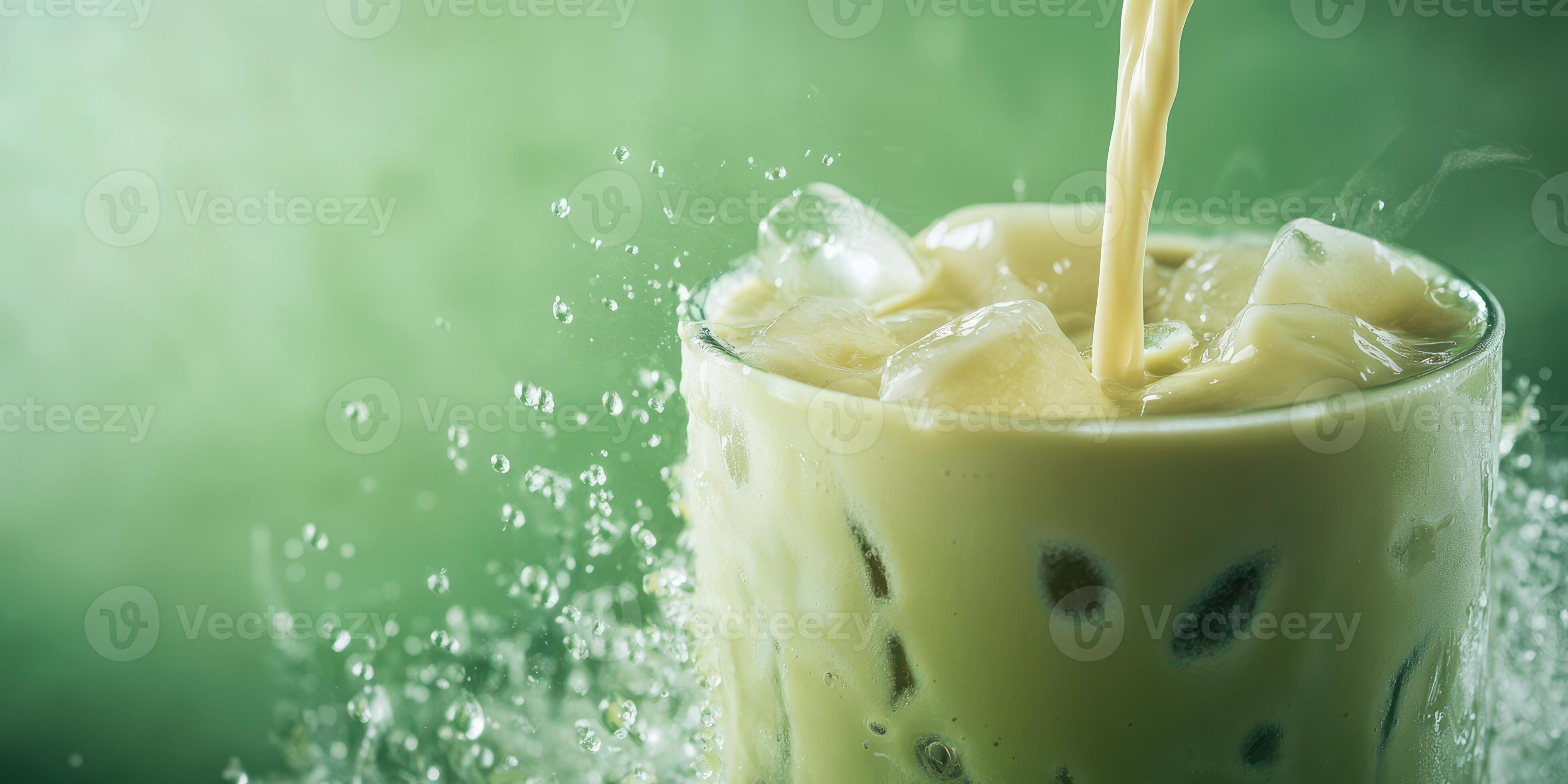 Refreshing beverage with ice poured into a glass over a green backdrop creating a lively scene ...