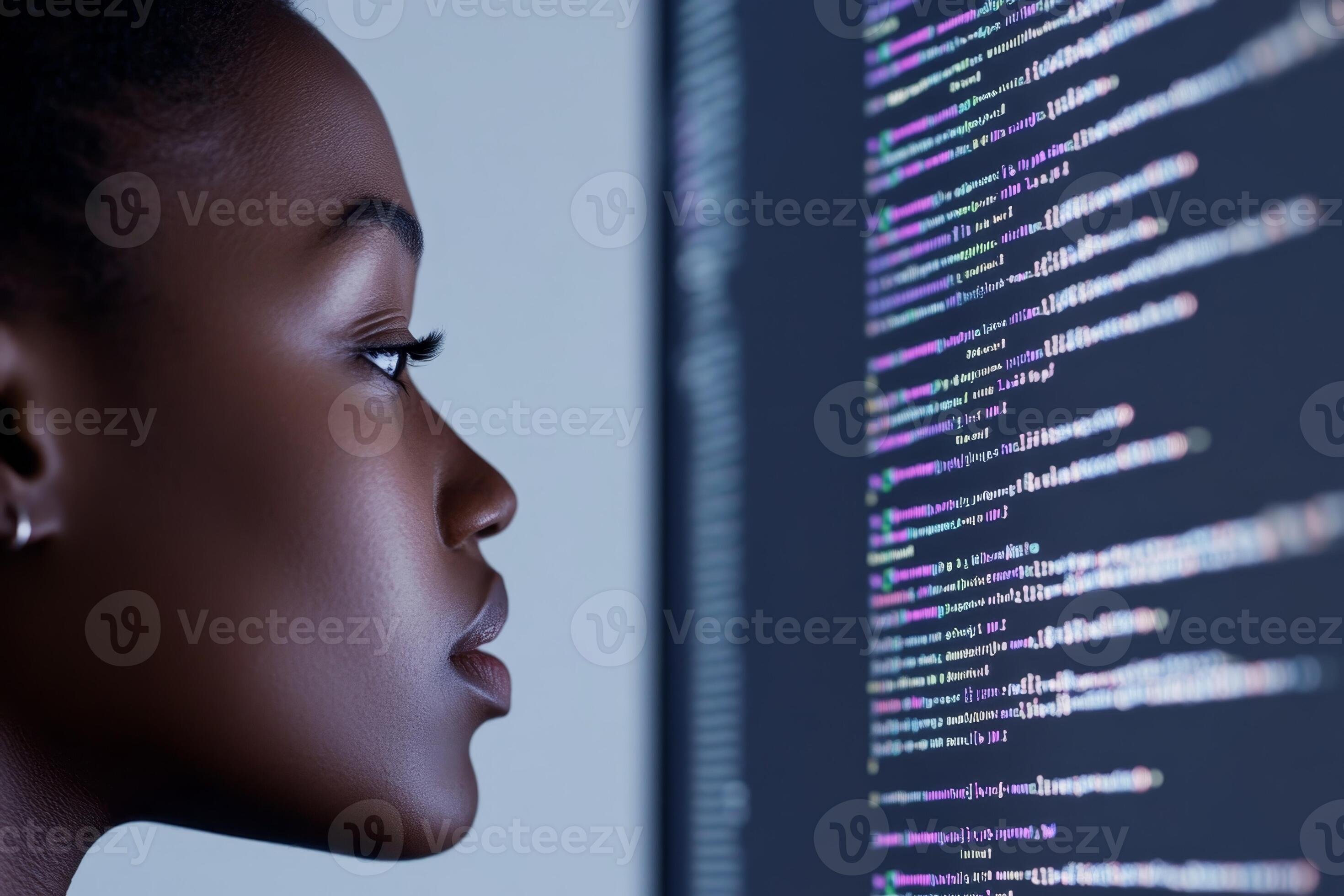 A Woman With Dark Skin Gazes Intently At A Computer Screen Displaying