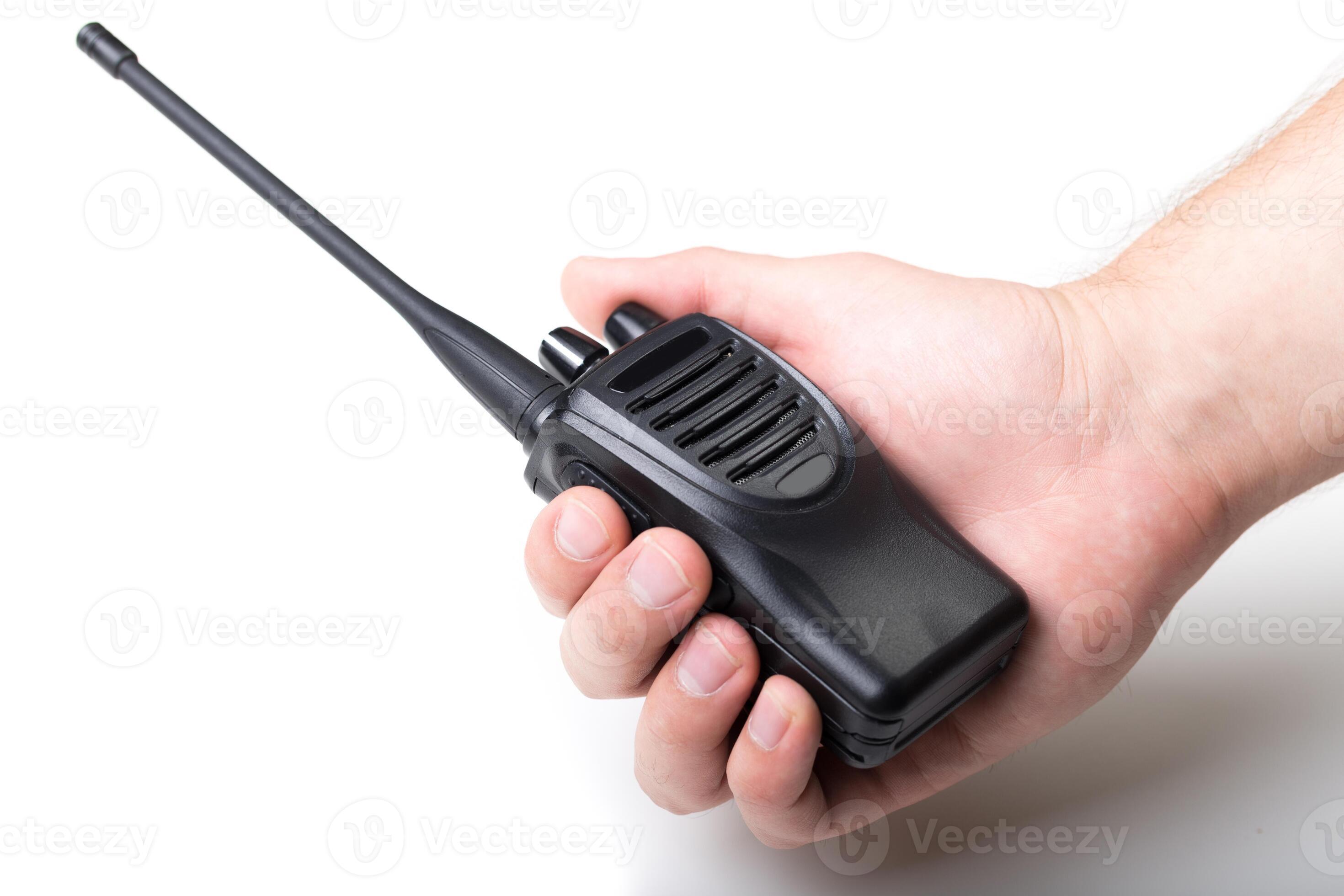 Handheld radio communication device held in a person's hand showing wireless capability and ...