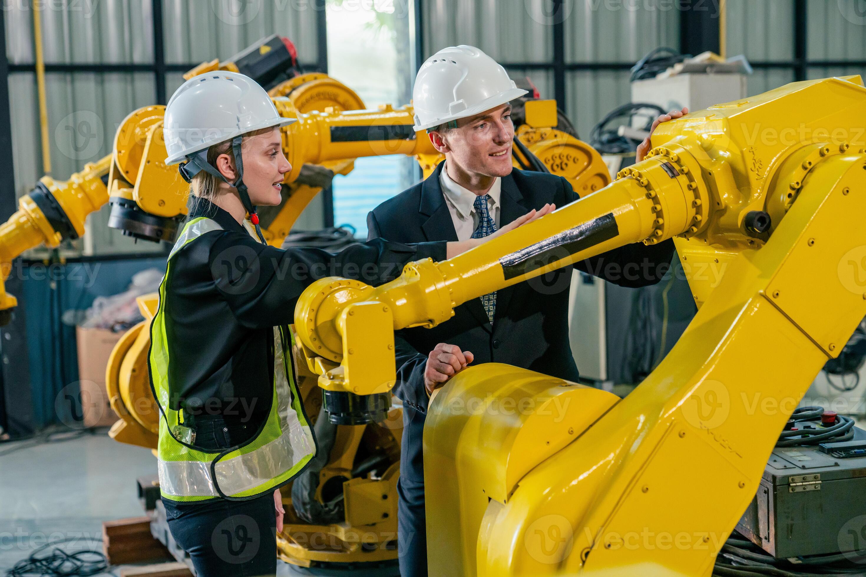 Engineers collaborate in a robotics workshop, discussing automation and technology advancements ...