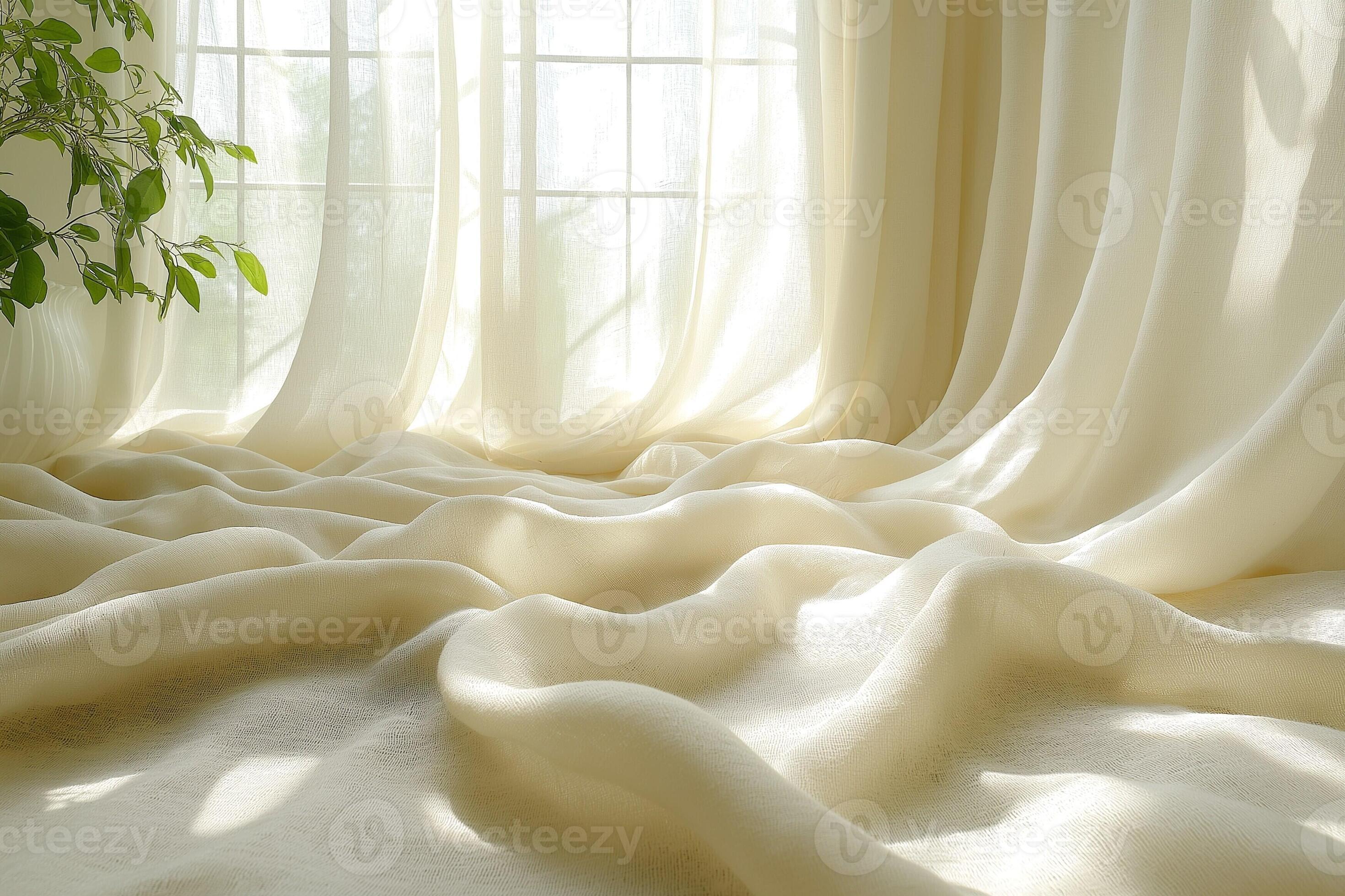 Soft white curtains gently drape and flow in the sunlight, creating a serene and calming ...