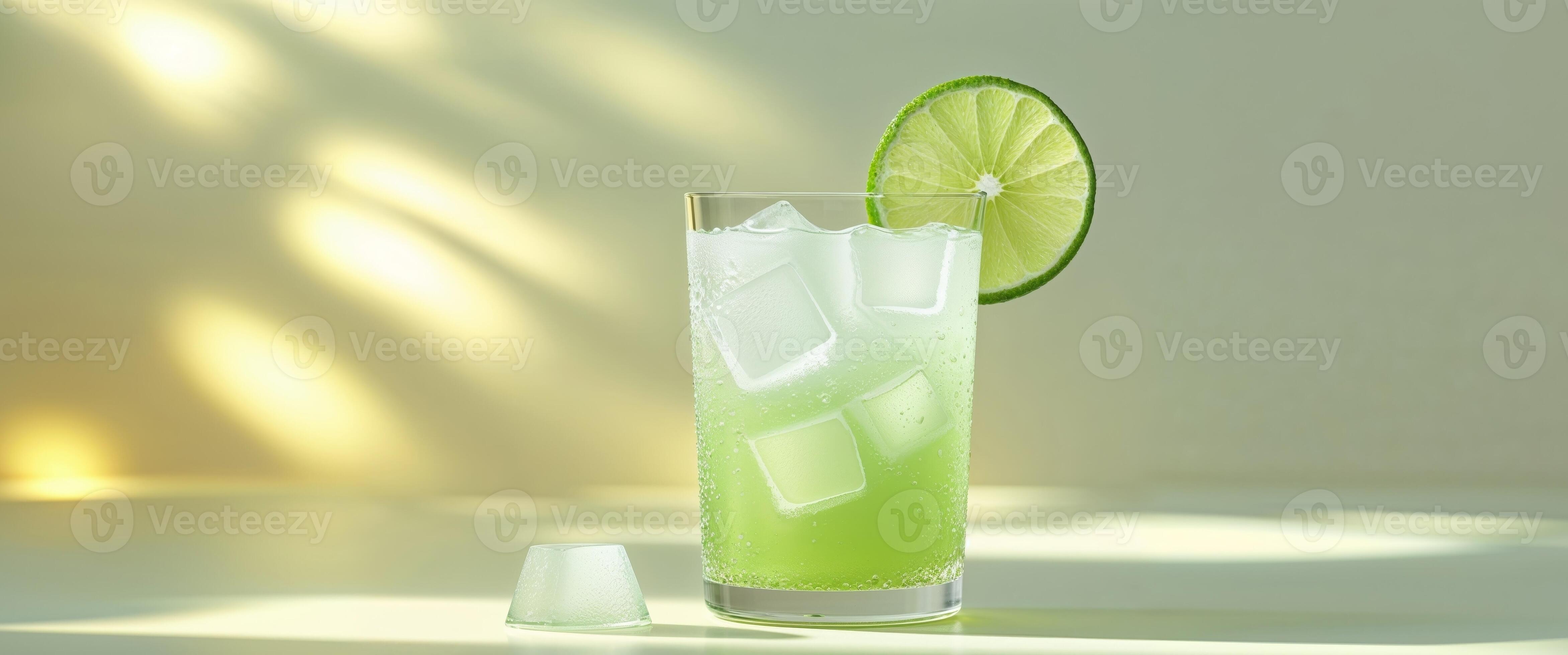 Refreshing glass of limeade with ice and lime slice in sunlit setting 56792962 Stock Photo at ...