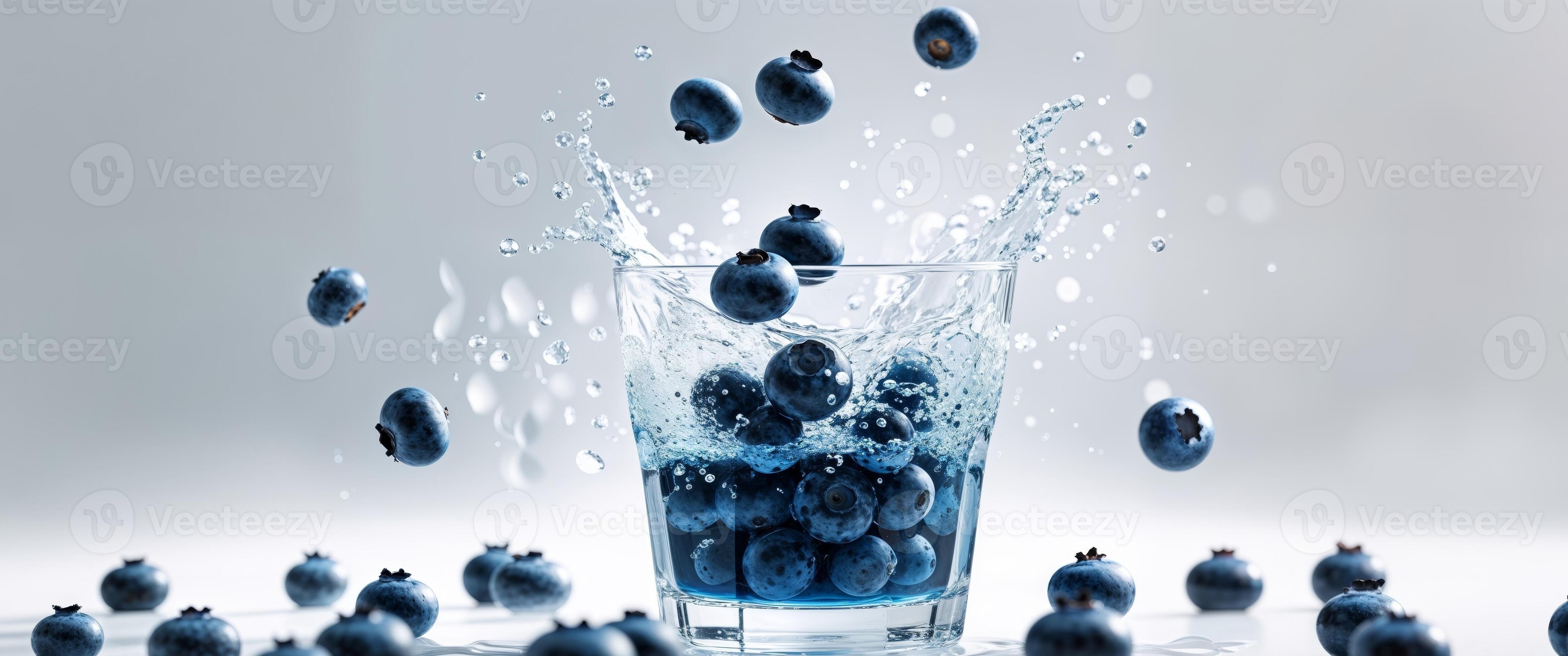 Fresh blueberries splashing into a glass of refreshing juice 56993589 Stock Photo at Vecteezy
