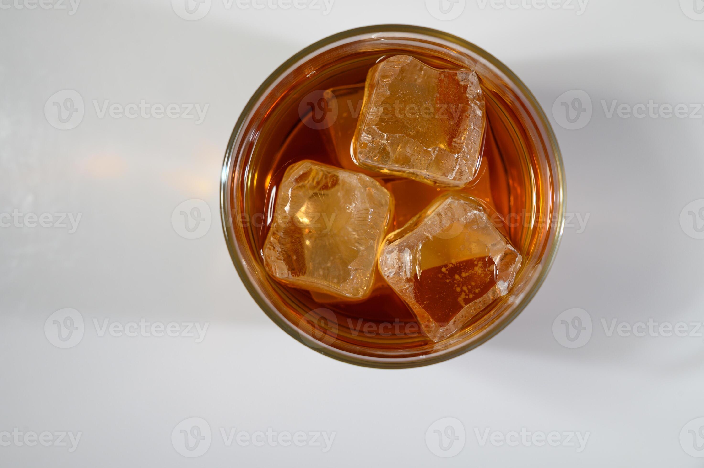 Refreshing amber drink with ice cubes in a glass for a cozy afternoon 57050904 Stock Photo at ...
