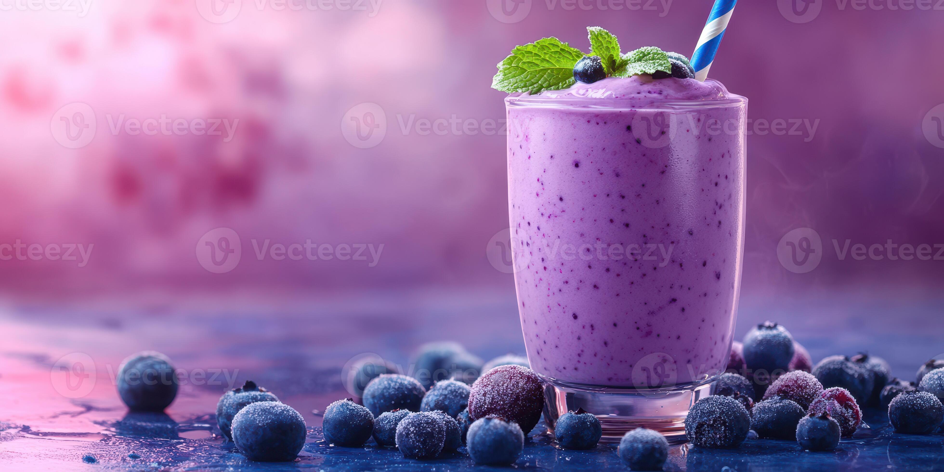Fresh blueberry smoothie served in a clear glass with mint garnish on a rustic table 57196054 ...