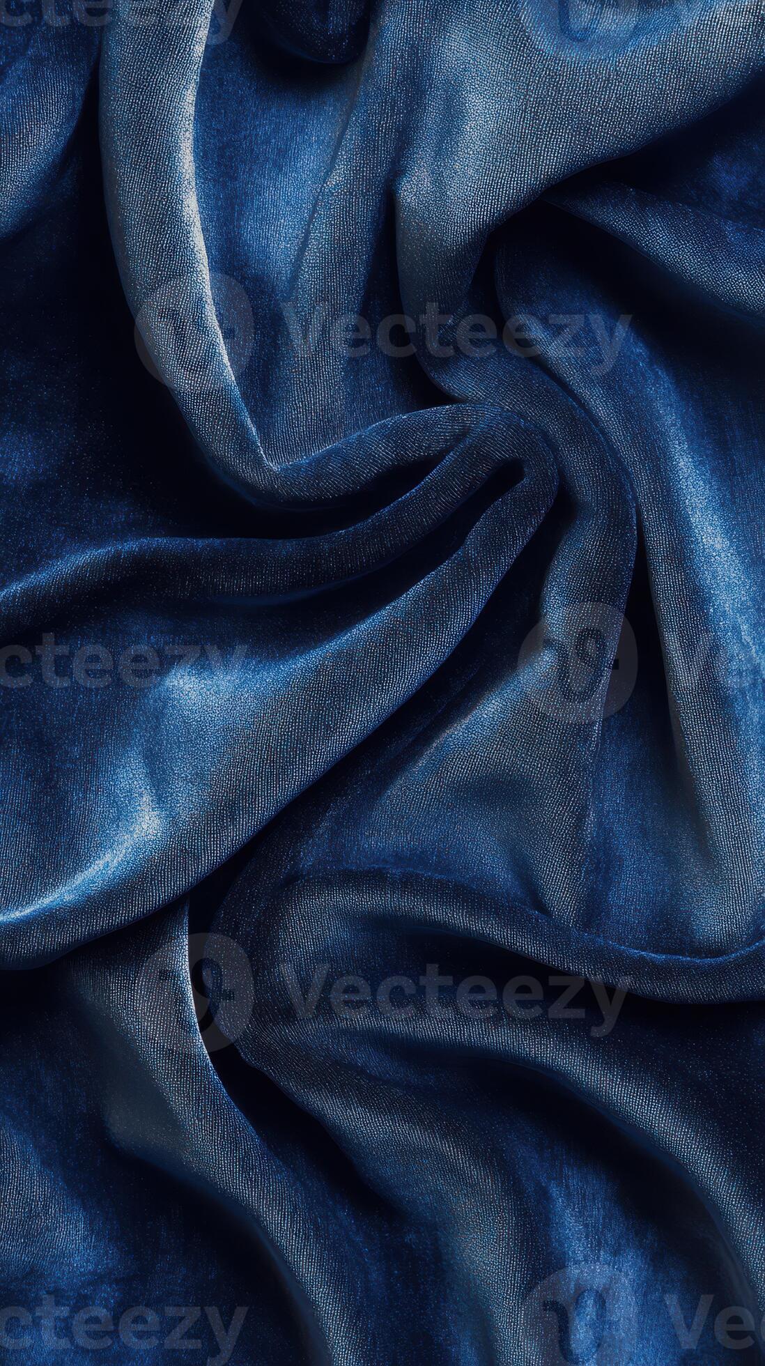 Elegant deep blue satin fabric draping softly with smooth and luxurious texture in indoor ...