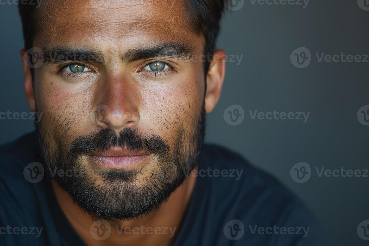 Close-up portrait of a young athletic man with striking blue eyes and a ...