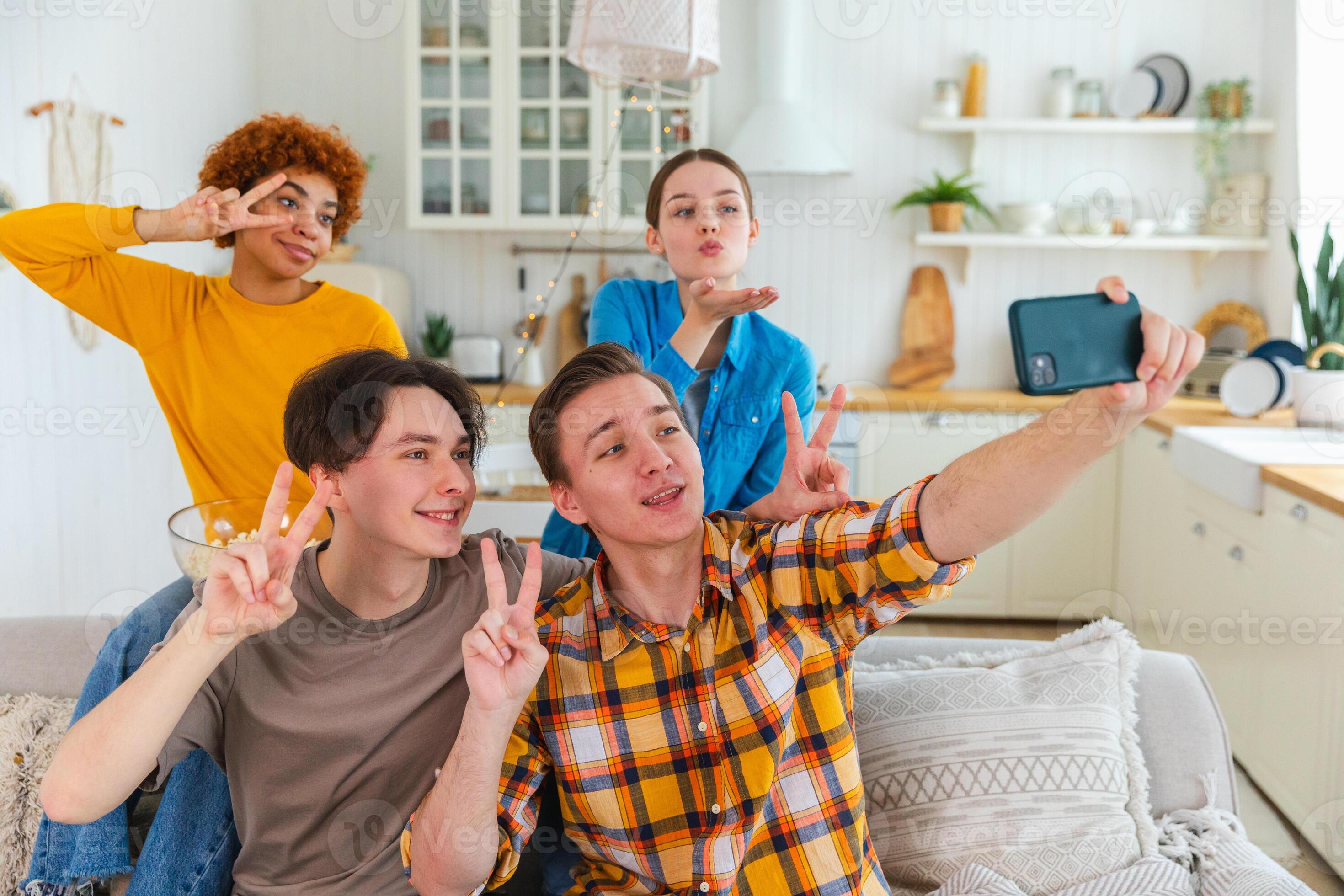 Cheers Funky mood. Happy group of friends make selfie. Man taking photo of friends at party ...