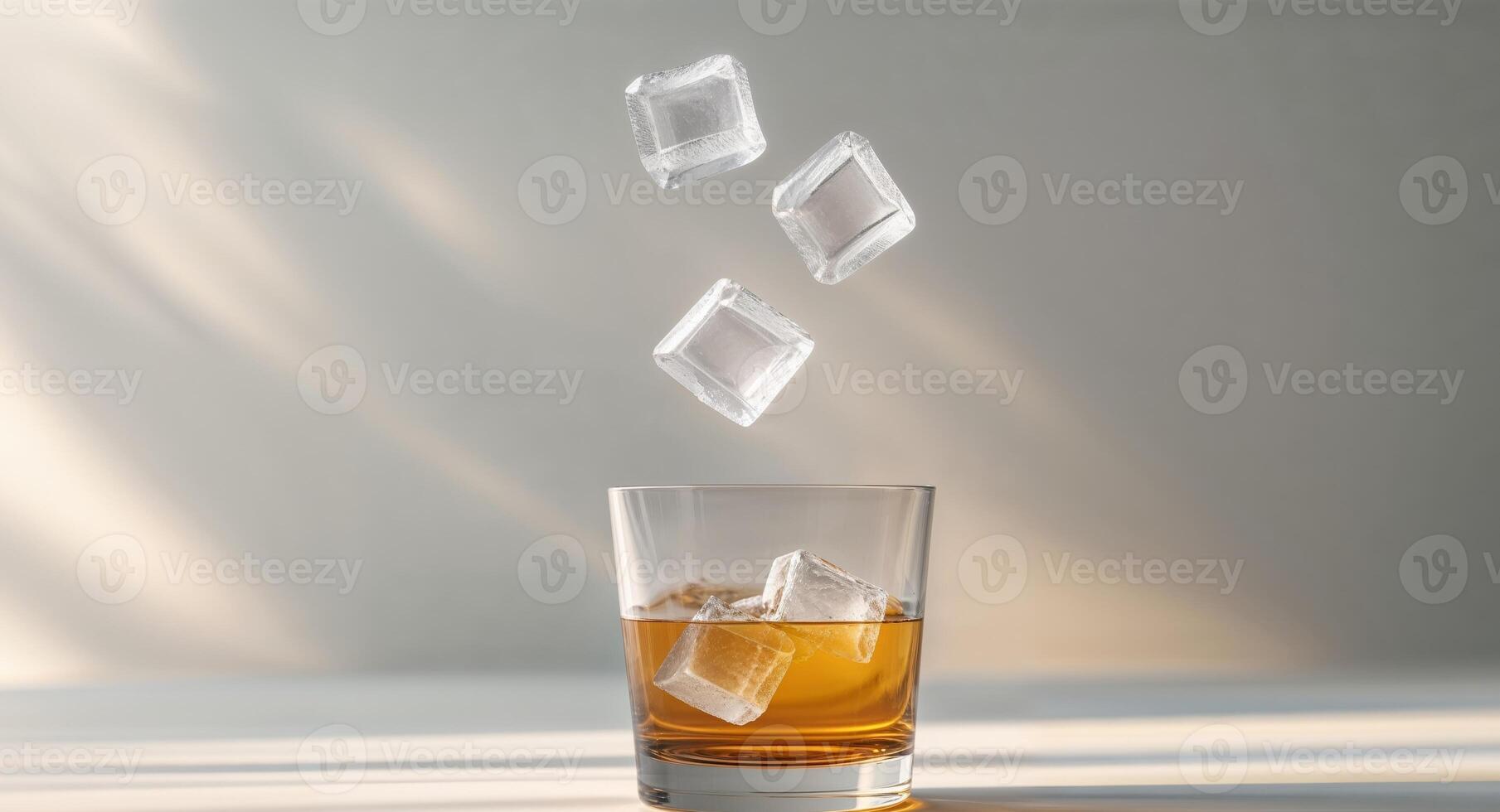 Ice cubes falling into a glass of amber liquid. 57494767 Stock Photo at Vecteezy