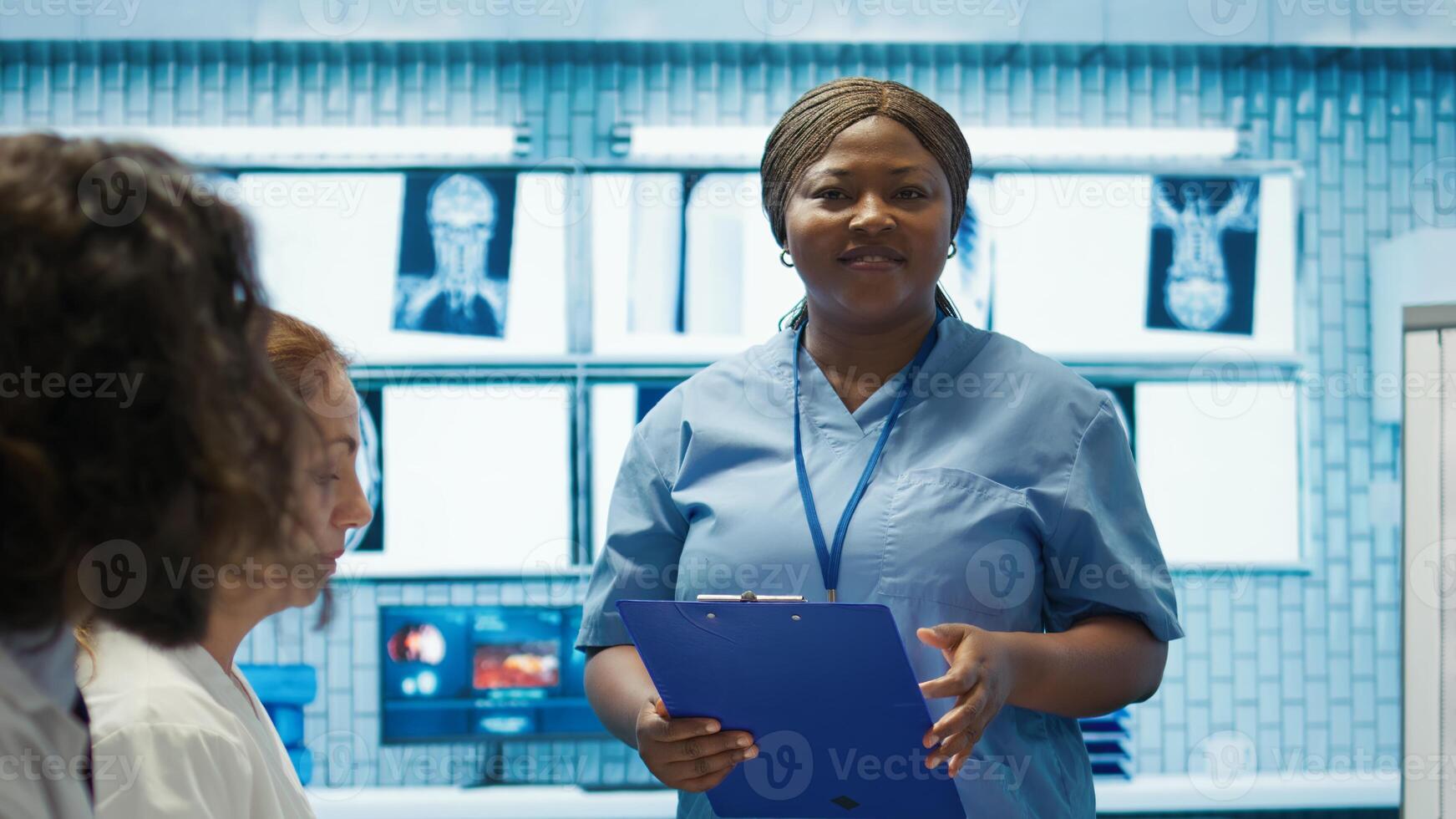 Medical team reviewing diagnostic x rays in a healthcare facility, focusing on disease ...