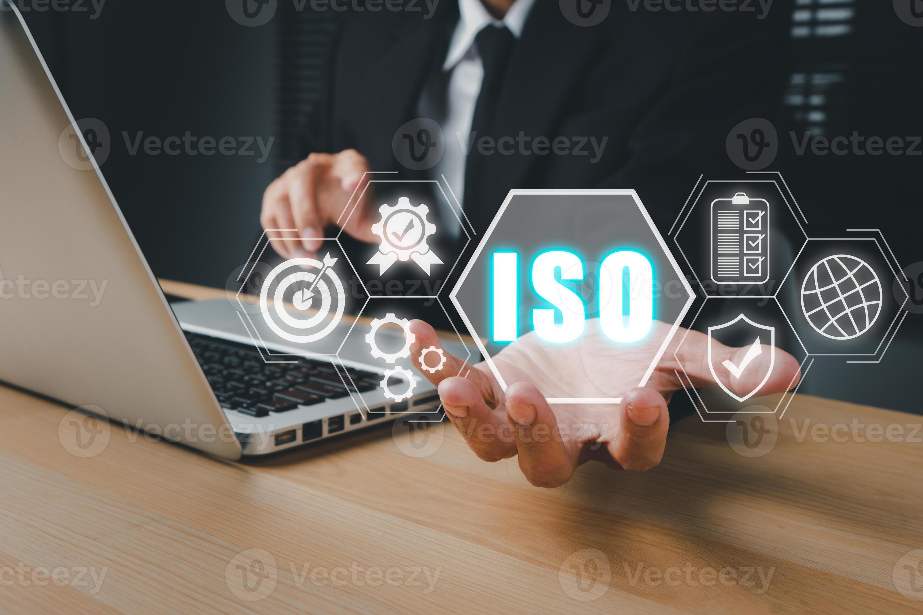 ISO standards quality control concept, Person hand holding iso icon on virtual screen on desk ...