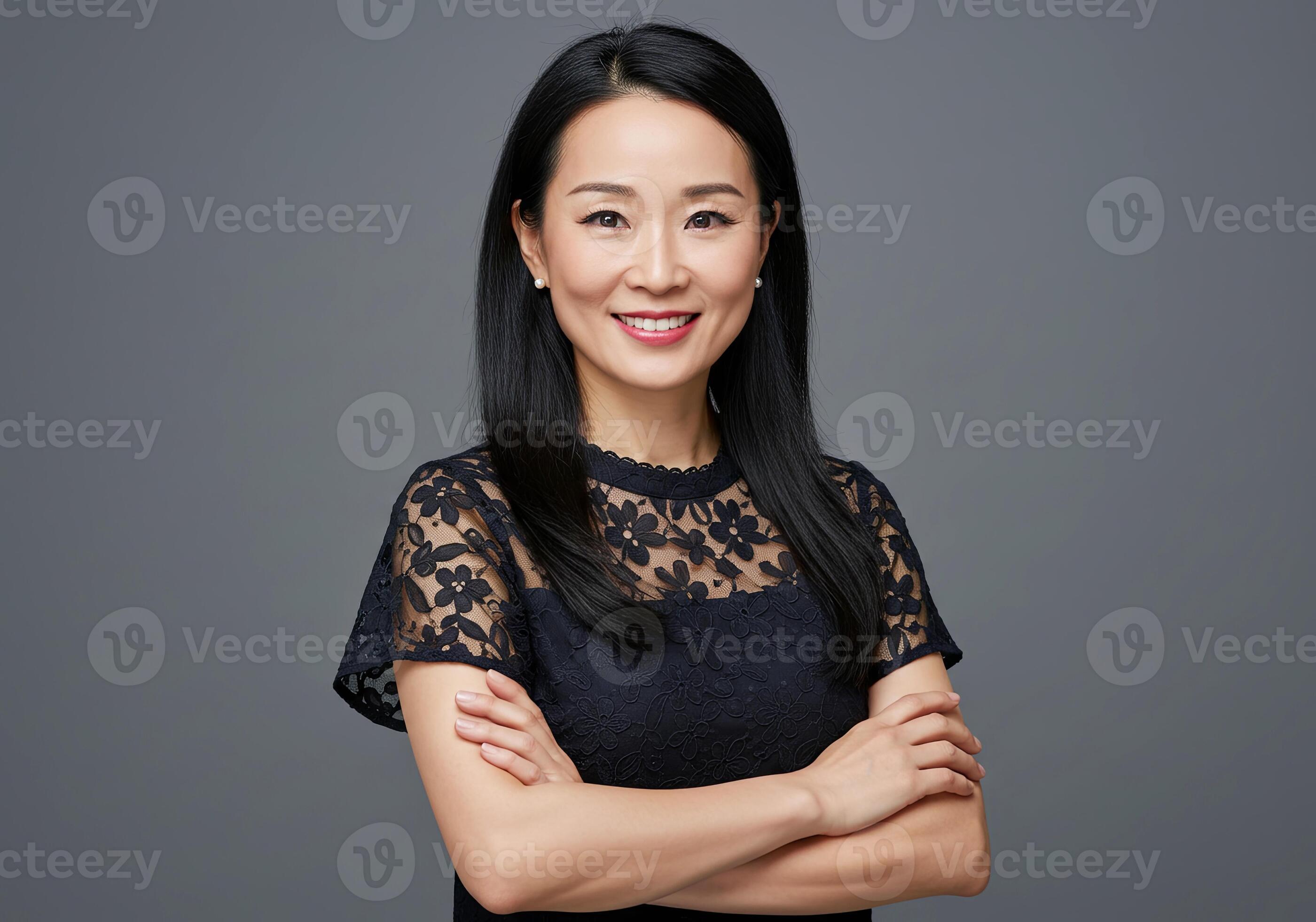 An asian woman in a black dress with her arms crossed 57779156 Stock Photo at Vecteezy