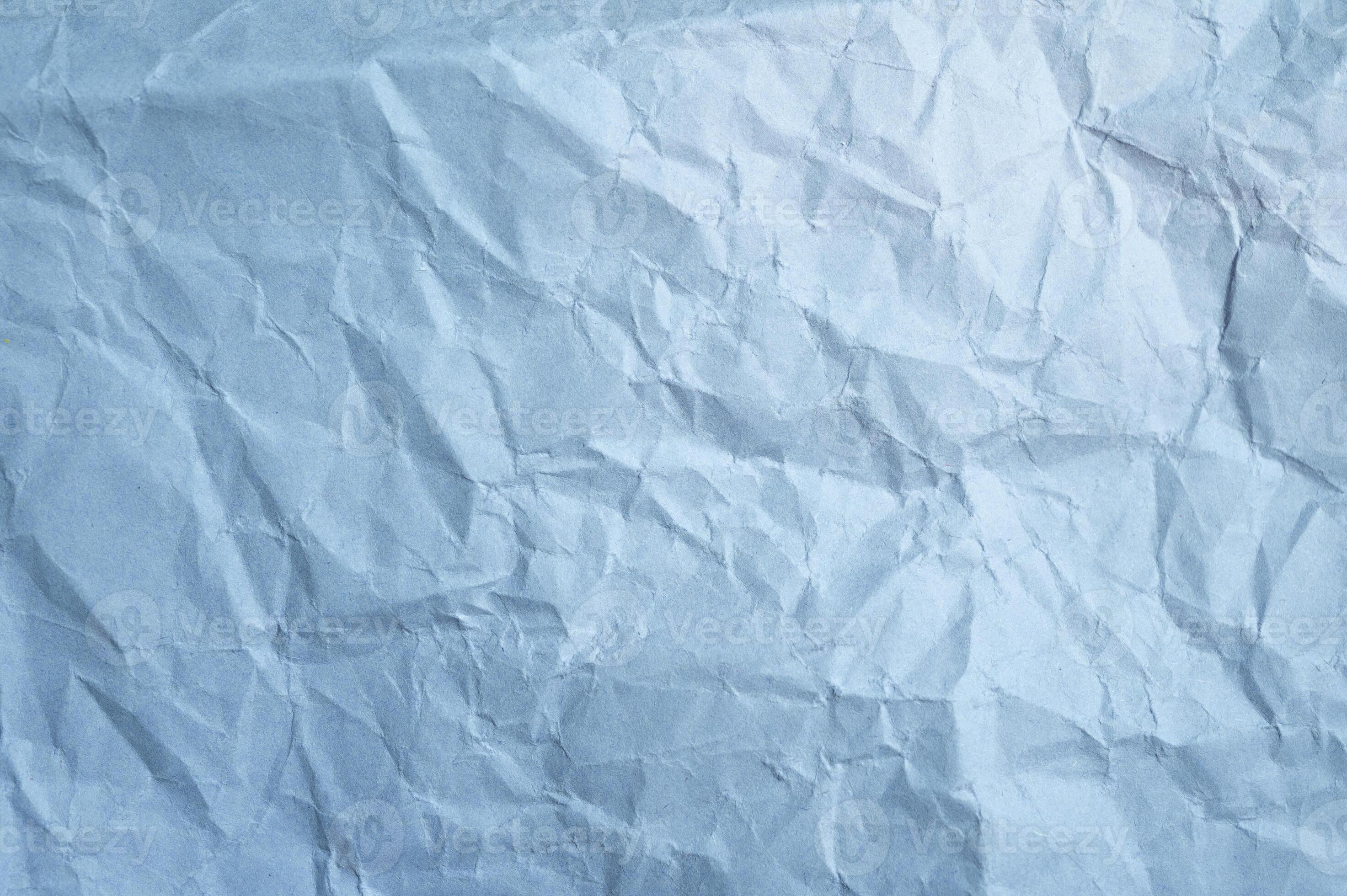 Full frame shot of crumpled light blue paper sheet texture and ...