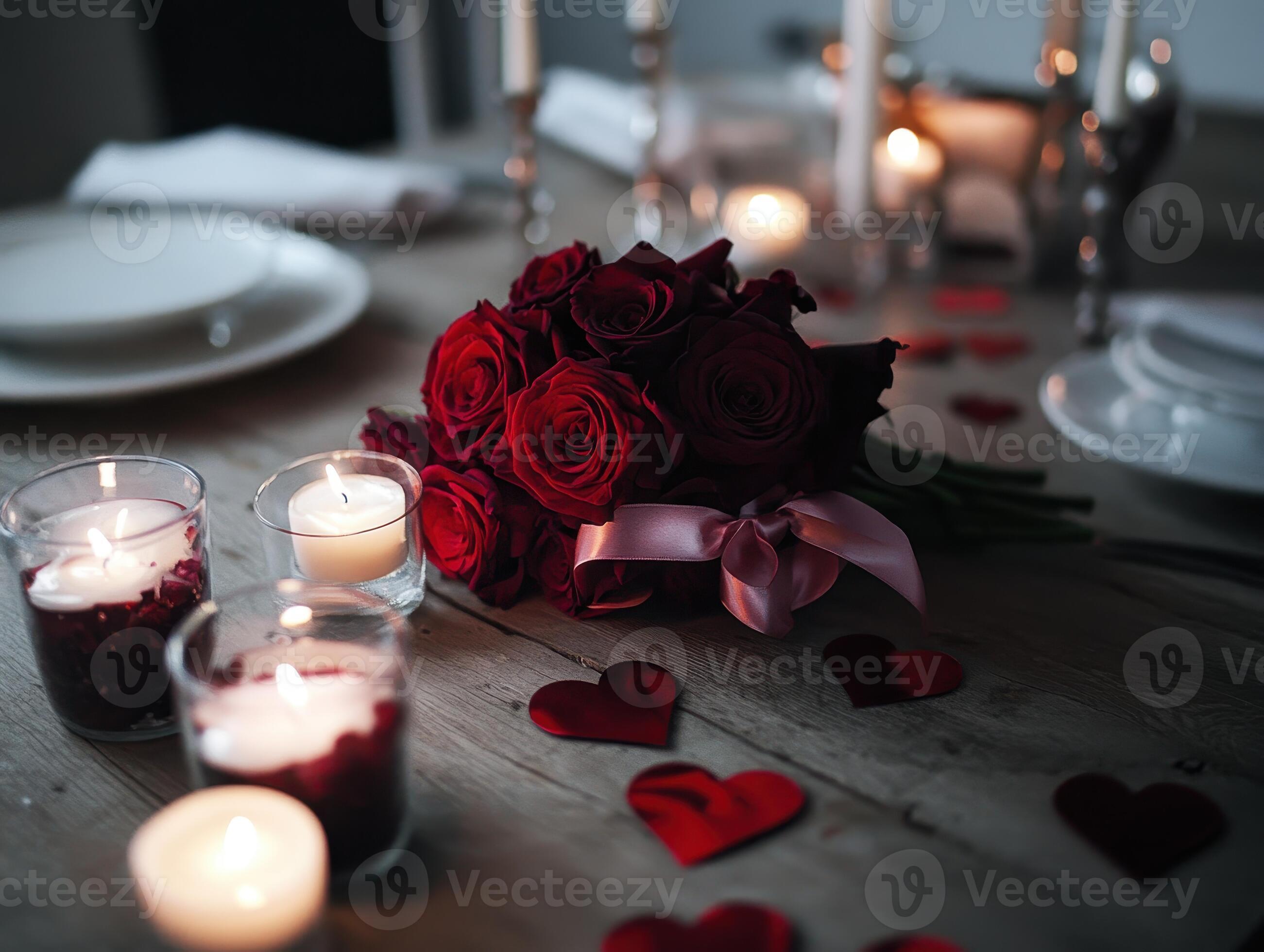 A romantic table setting with a bouquet of red roses, candles, and heart-shaped decorations ...