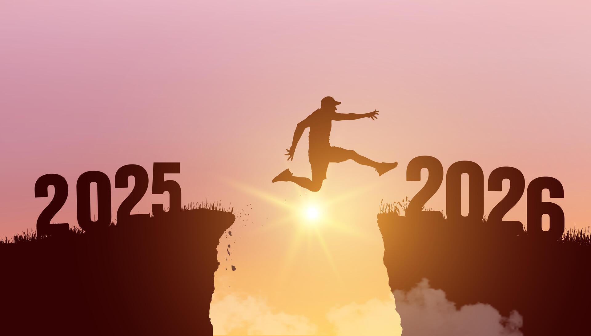 Man silhouette jumping on cliff 2026 over the precipice with stones at amazing sunset. New Year ...