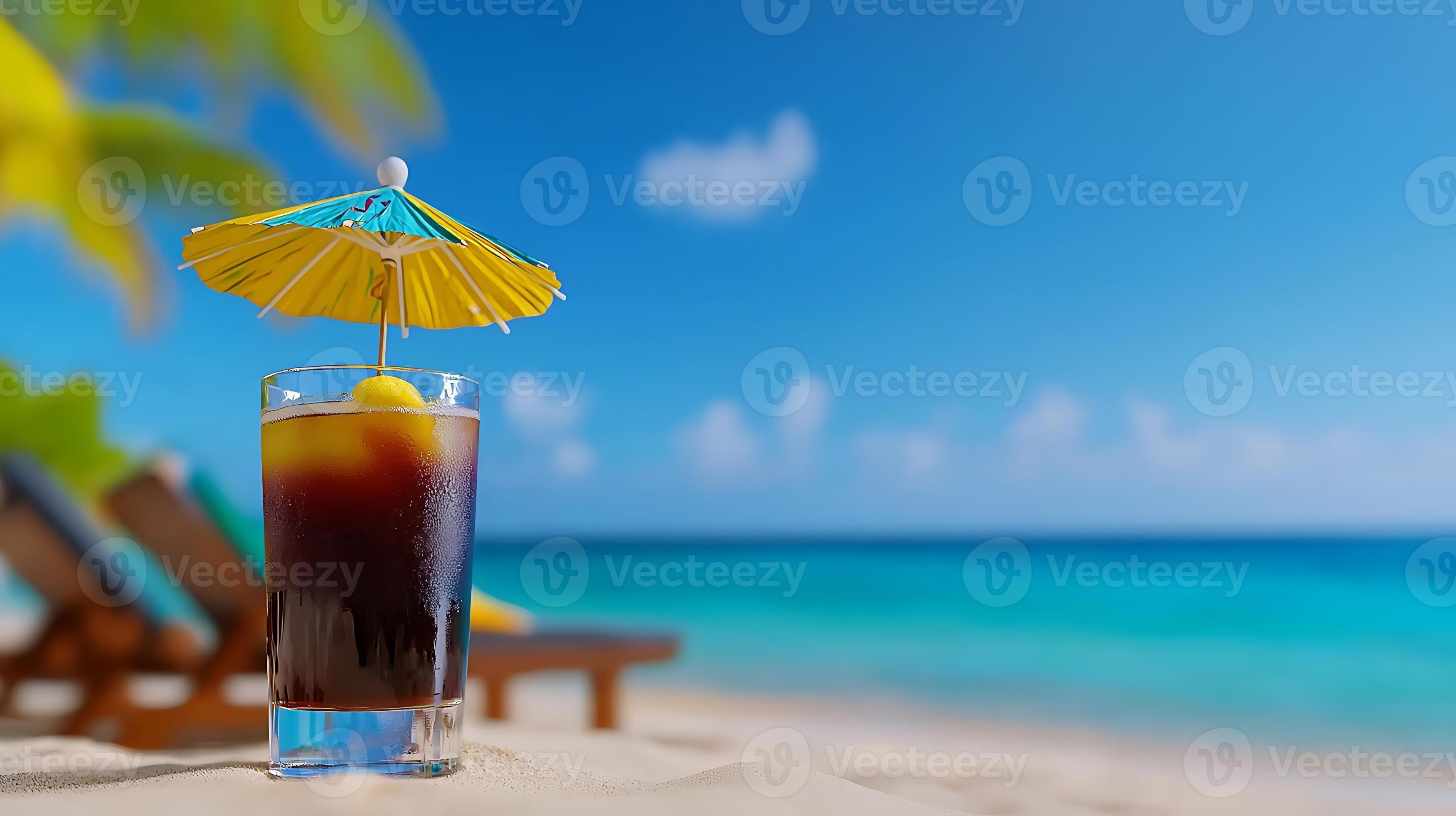 Refreshing tropical drink with a lemon slice and umbrella on a sandy beach by the ocean 58182263 ...