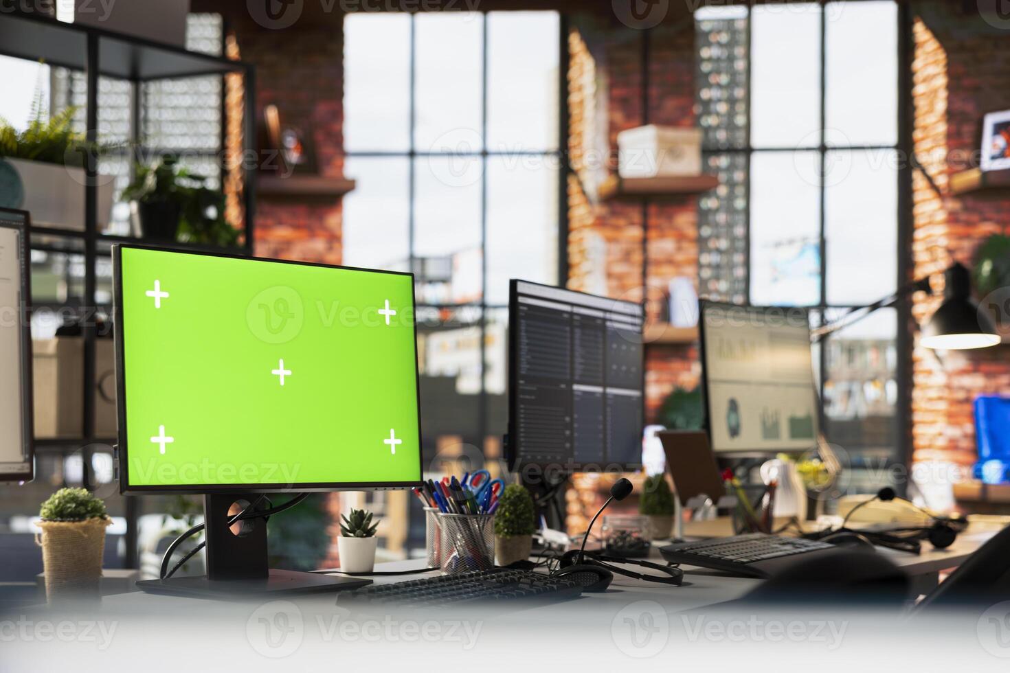 Green screen mockup PC monitors in empty call center office where unsatisfied customers call to ...