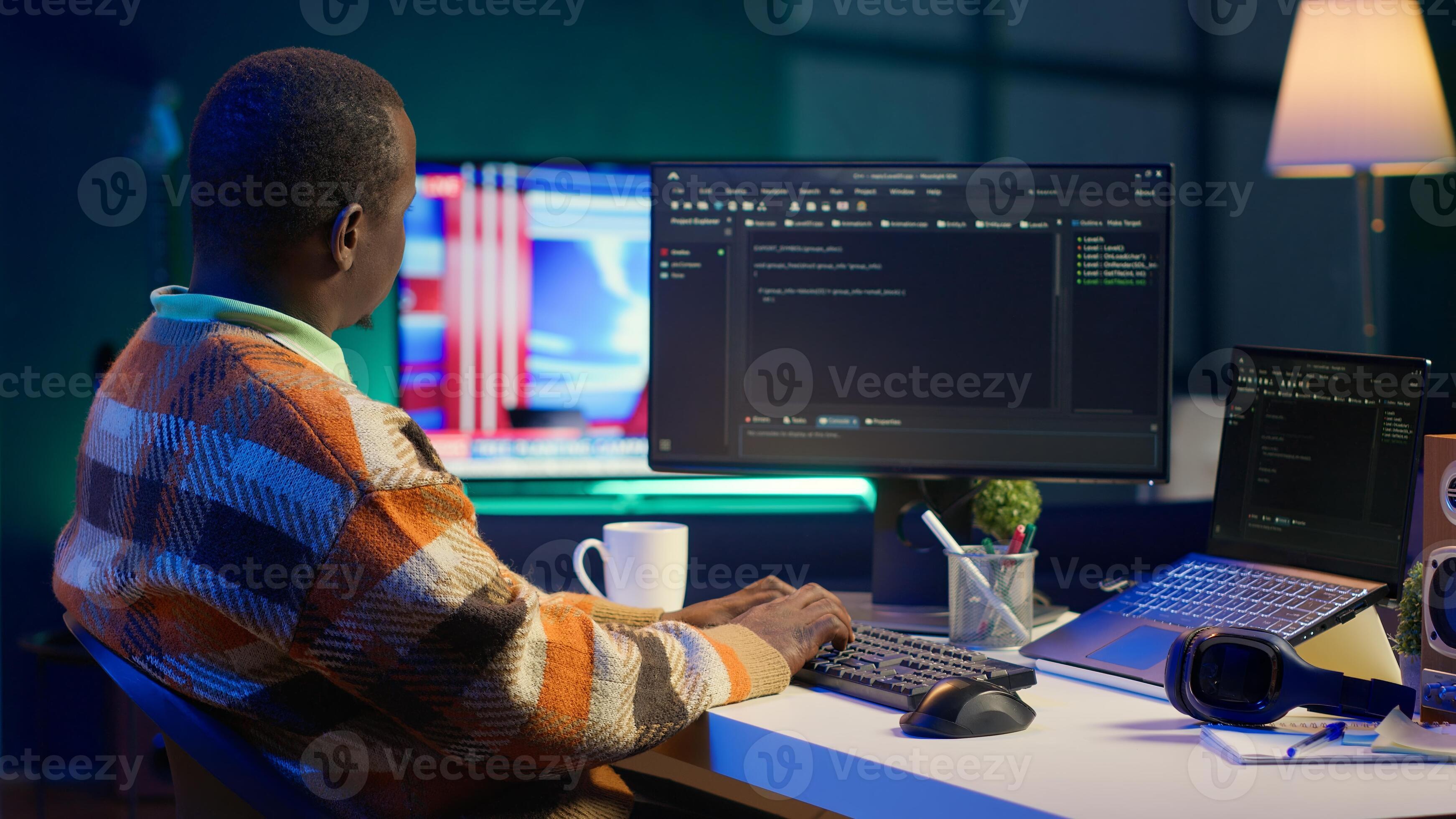 Programmer In Home Office Concentrating On Finding Bugs While He Codes On His Computer African