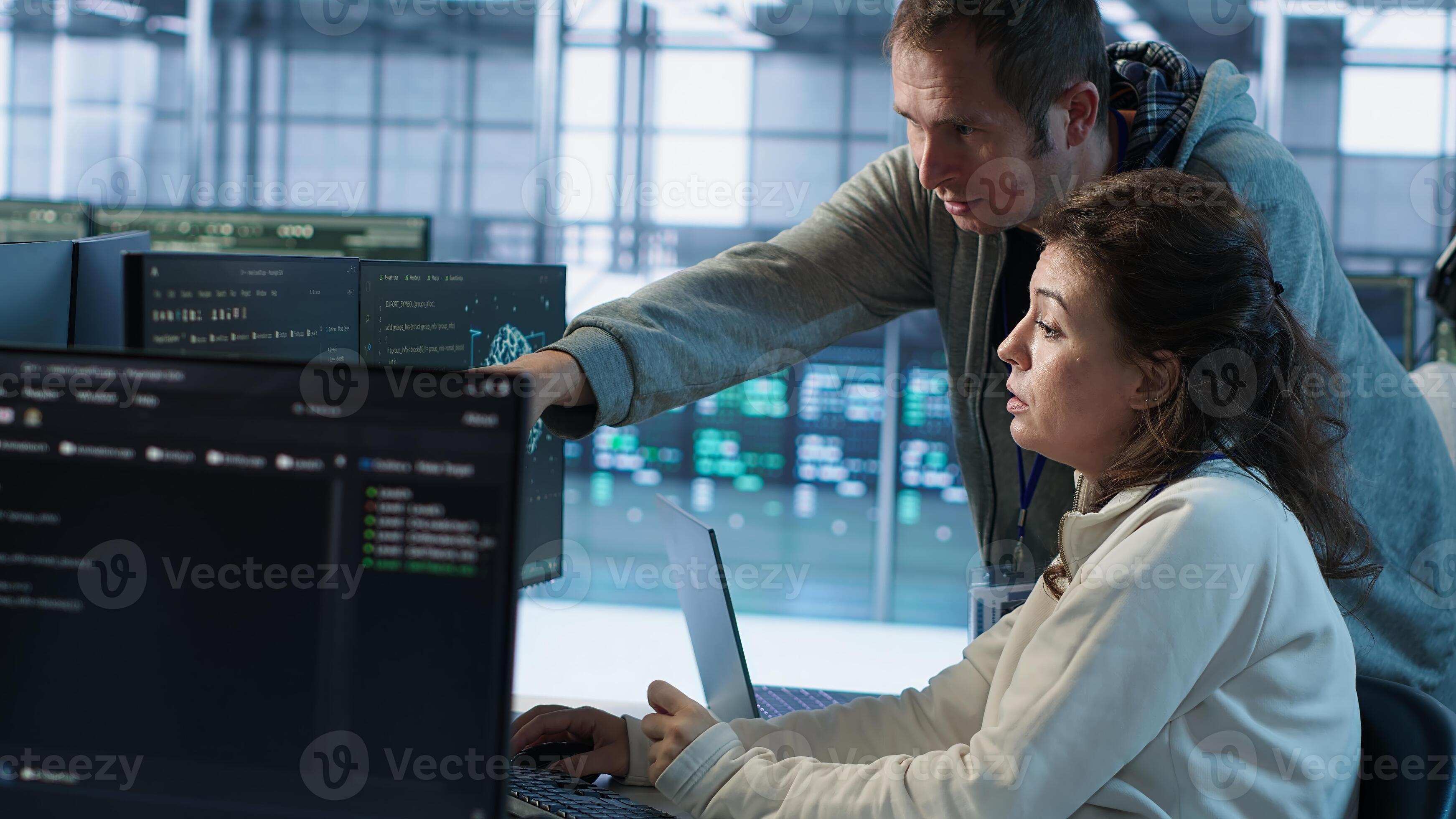 IT technicians in server farm brainstorming ways to repair equipment storing datasets ...