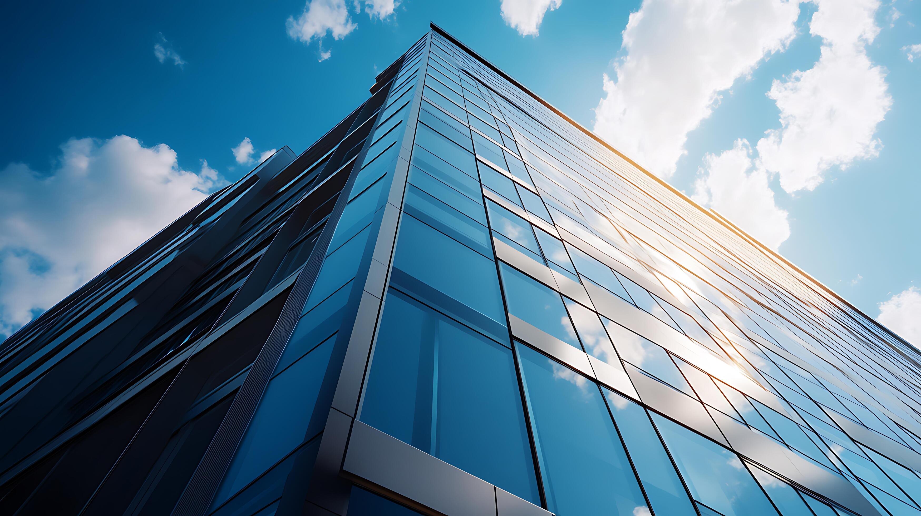 Modern glass building soaring toward a bright blue sky with fluffy ...