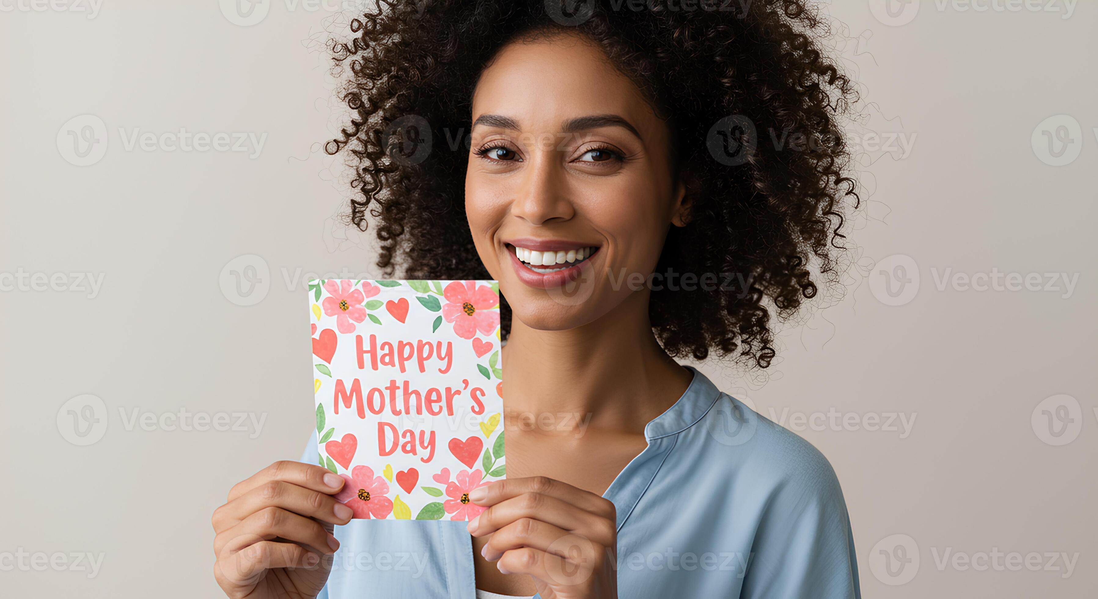 Happy woman celebrating Mother's Day, holding a delicate card as a ...