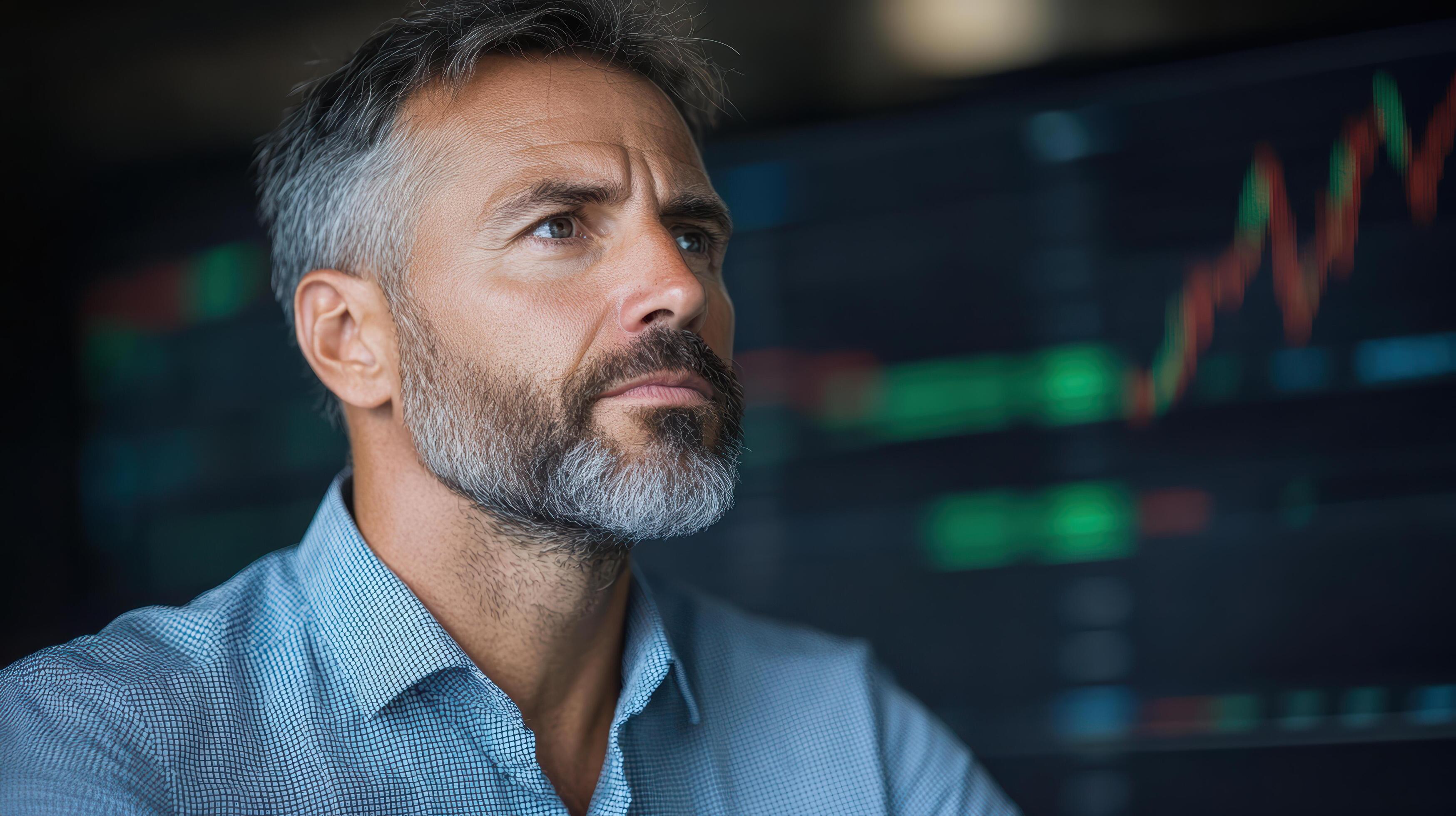 Focused trader analyzing market trends with stock charts background, showcasing determination ...