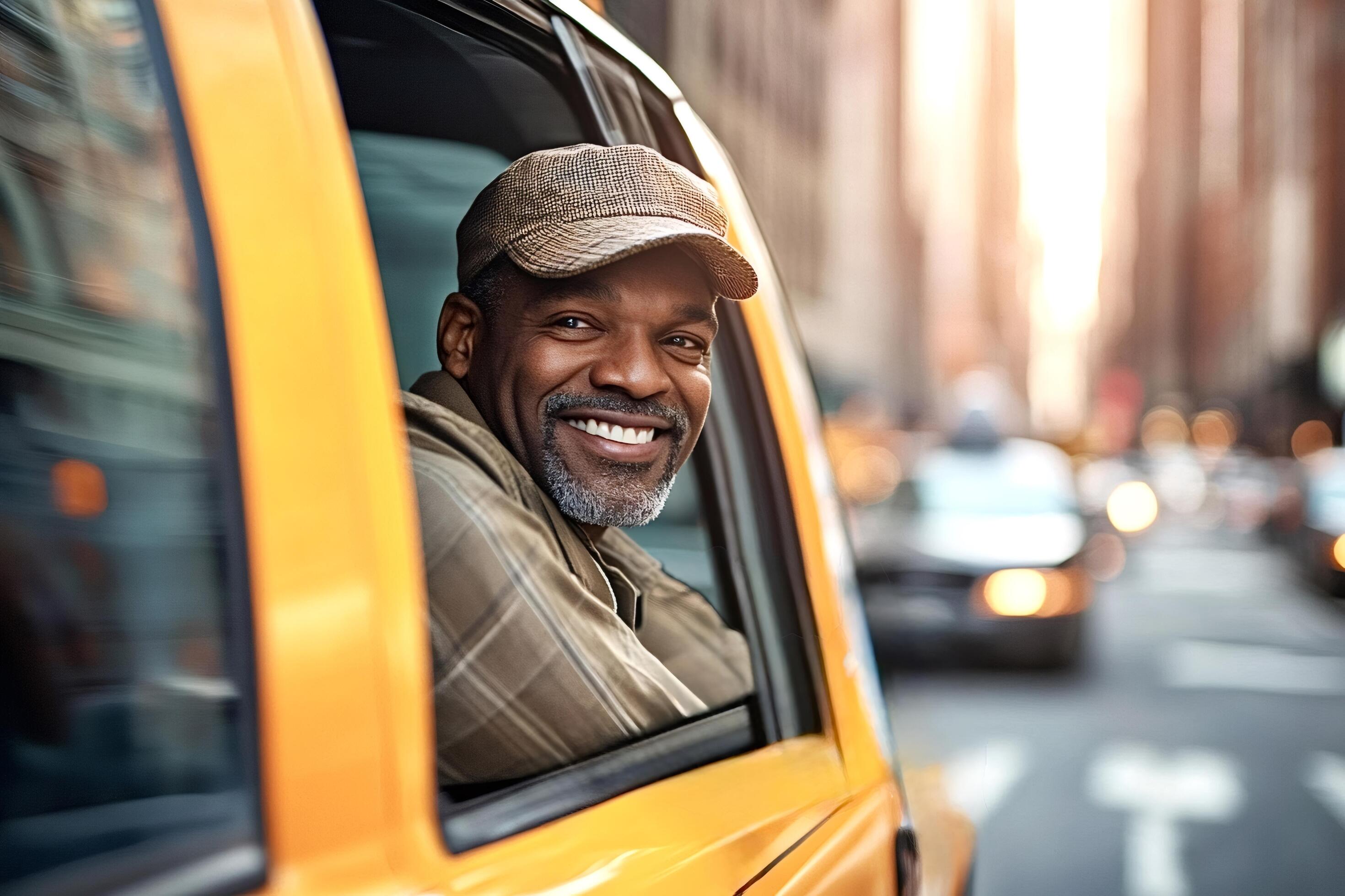 Smiling taxi driver looking out of yellow cab in new york city 60002858 ...
