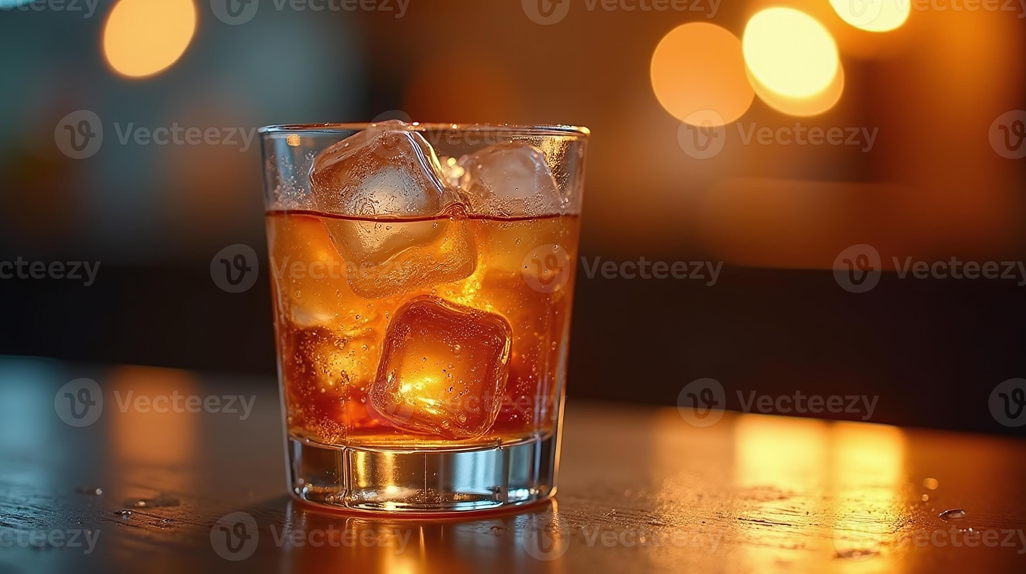 A glass of amber beverage with ice cubes. 60564320 Stock Photo at Vecteezy