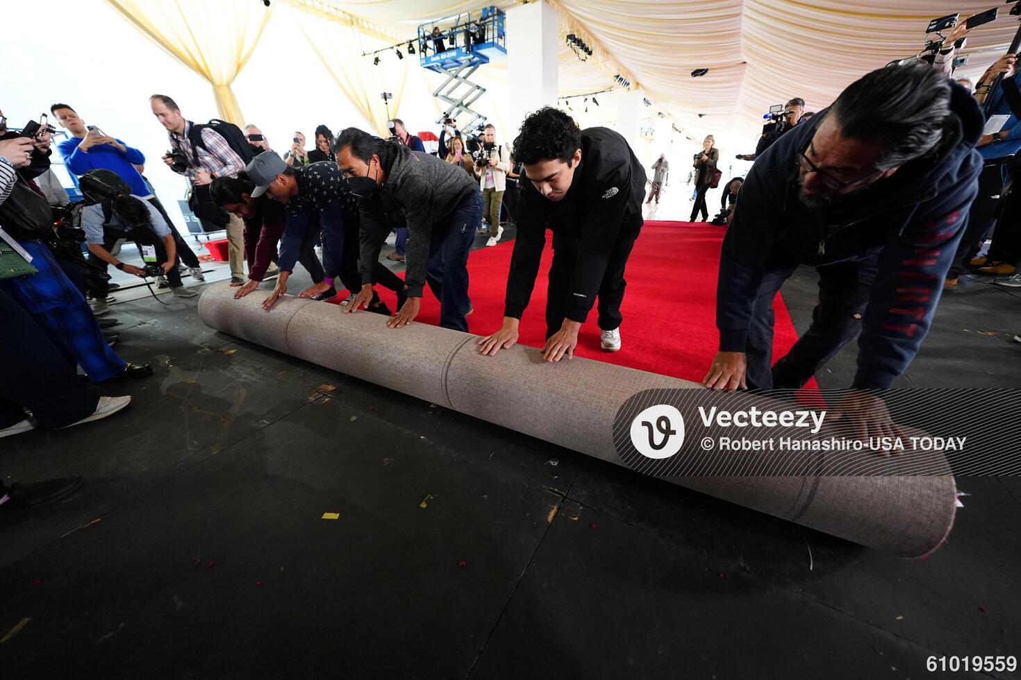 Workers during the ceremonial “red carpet rollout” event before the 94th annual Academy Awards ...