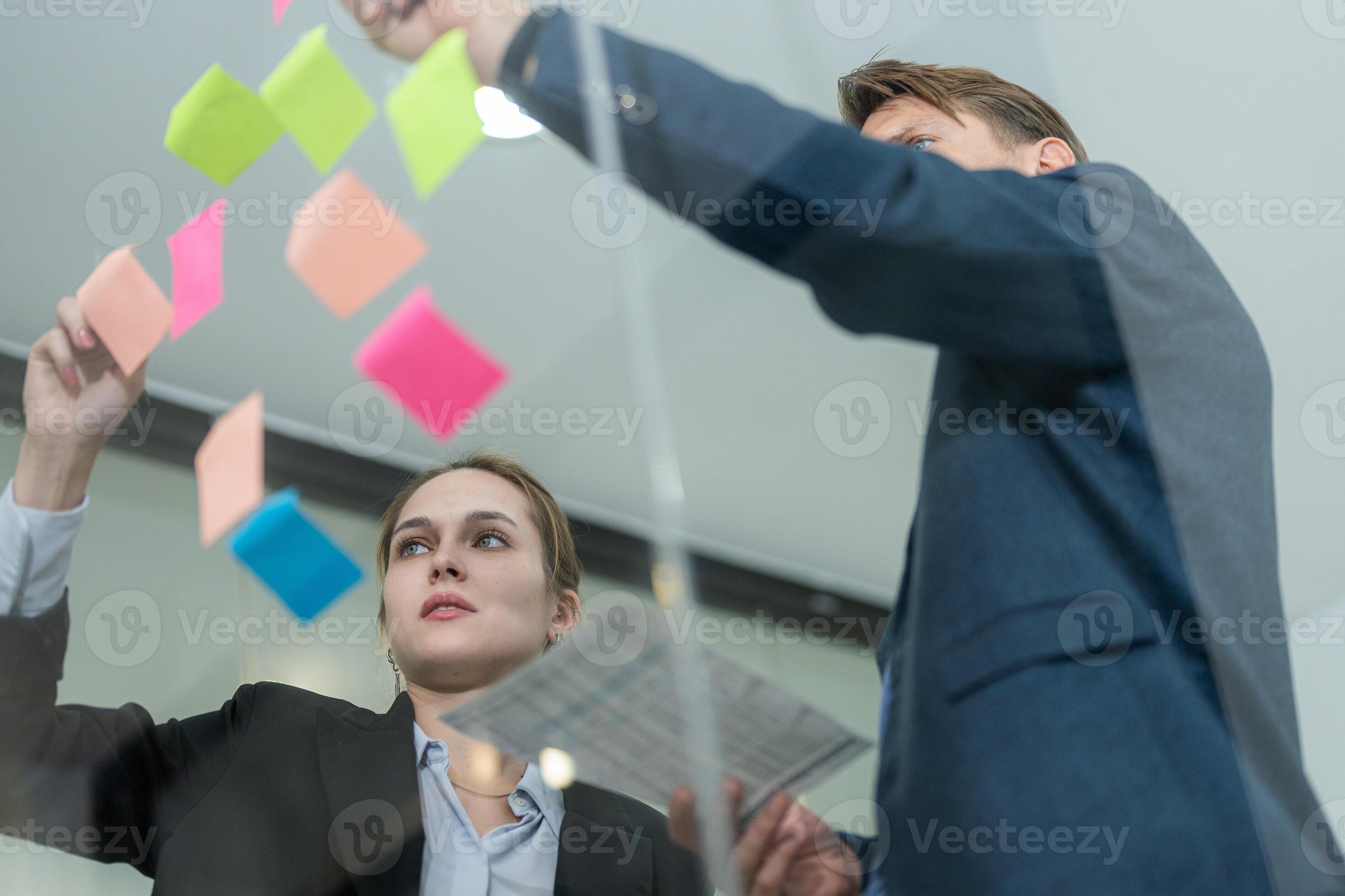 Business Team Collaborating On Project Ideas Using Colorful Sticky