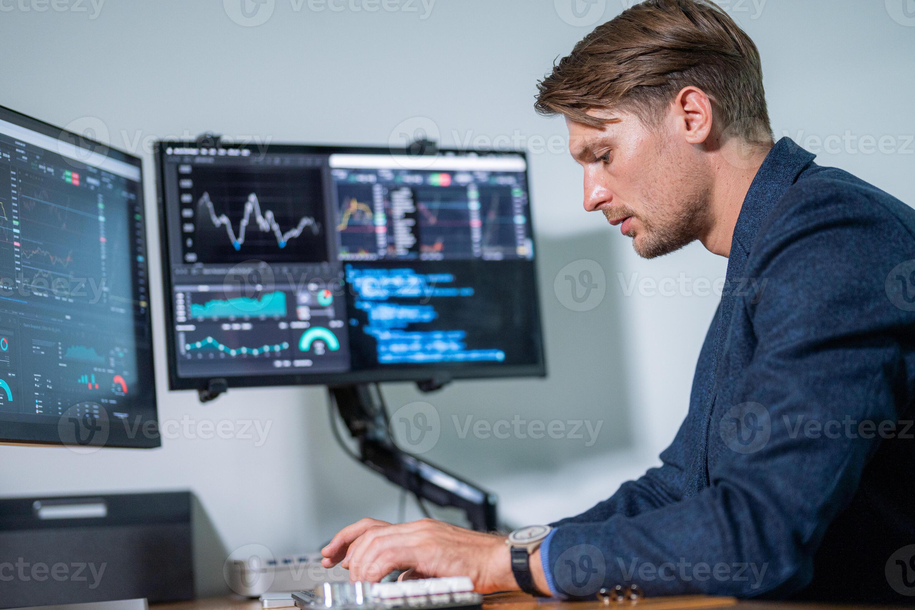 Man Analyzing Data On Multiple Screens In A Modern Office Environment