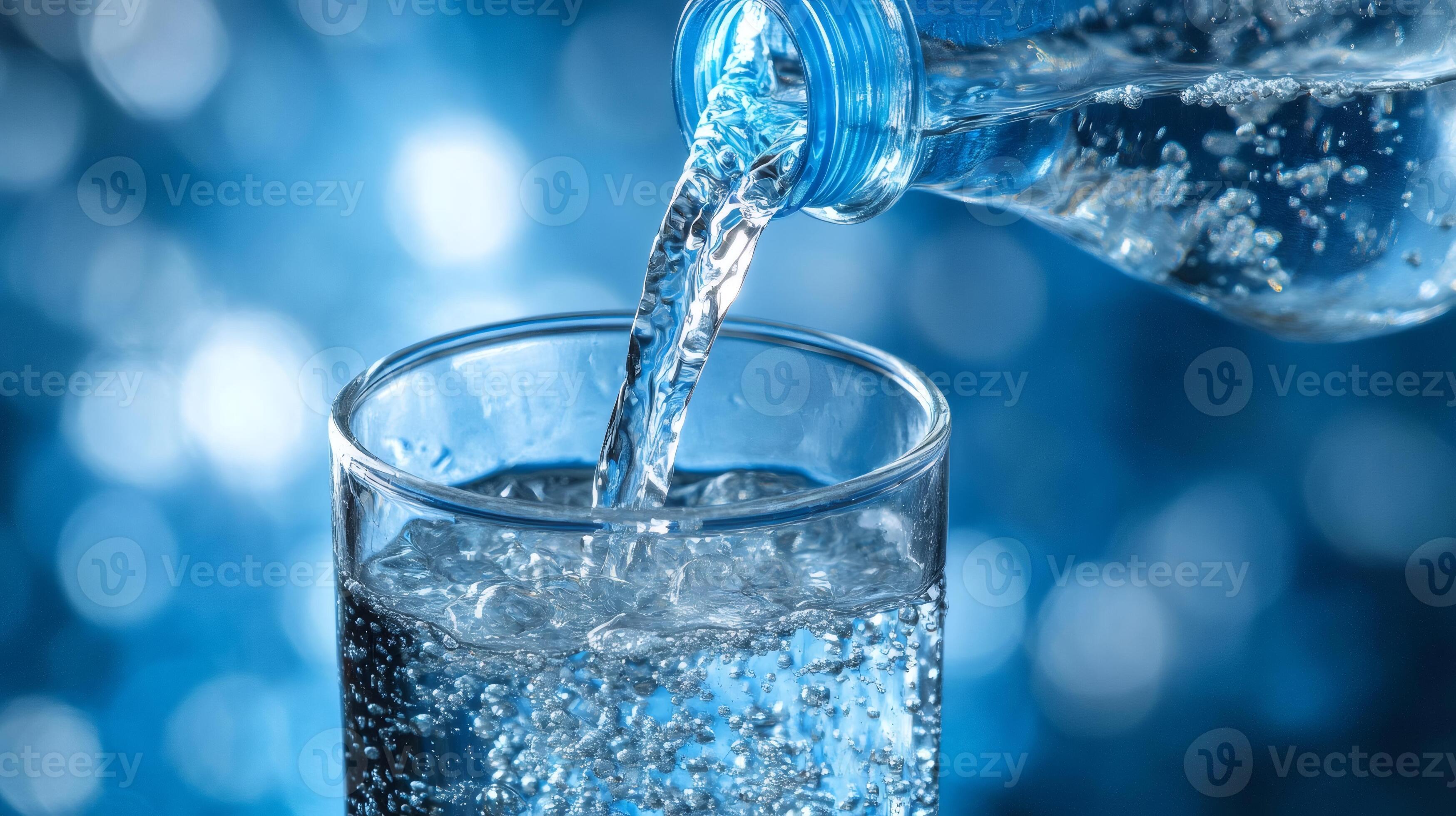 Pouring sparkling water from plastic bottle into glass on blue bokeh background 62446858 Stock ...