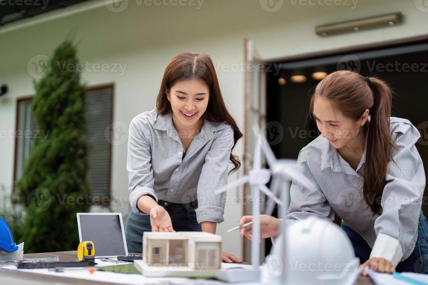 Sustainable Practices in Architecture. Architects reviewing plans for ...