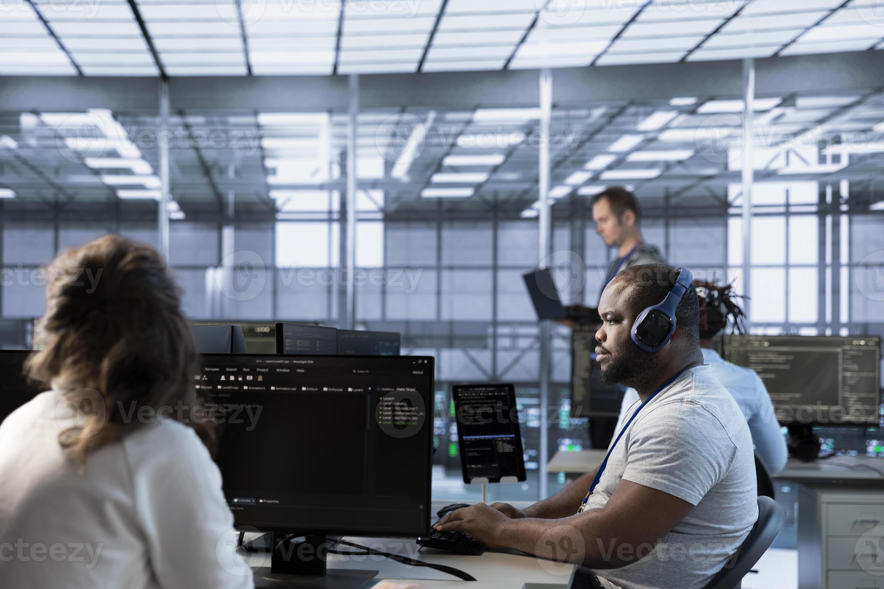 African american man in data center coordinating deployment of server architecture, improving ...