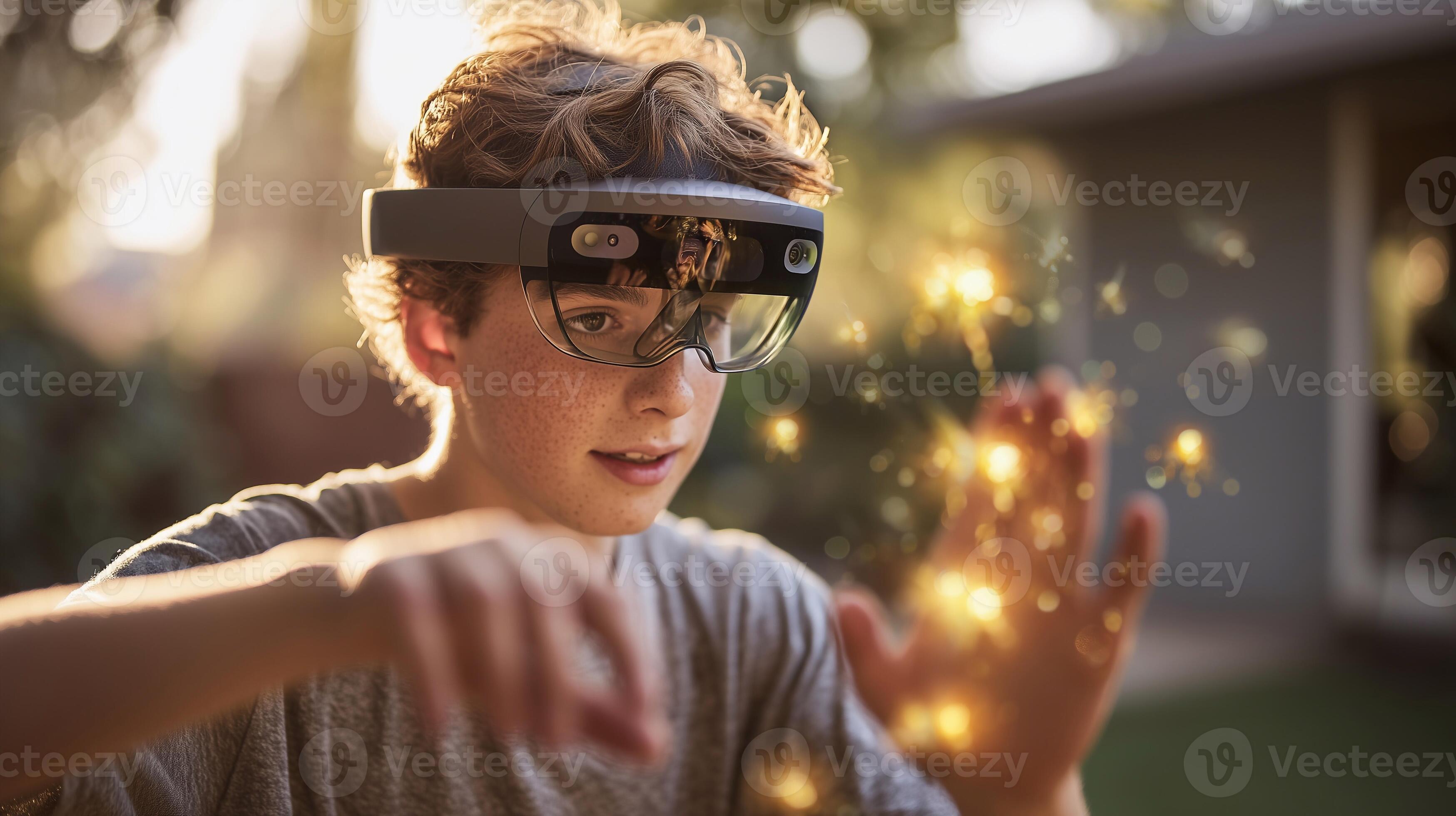 Boy using augmented reality headset outdoors, interacting with glowing holograms. Concept of ...