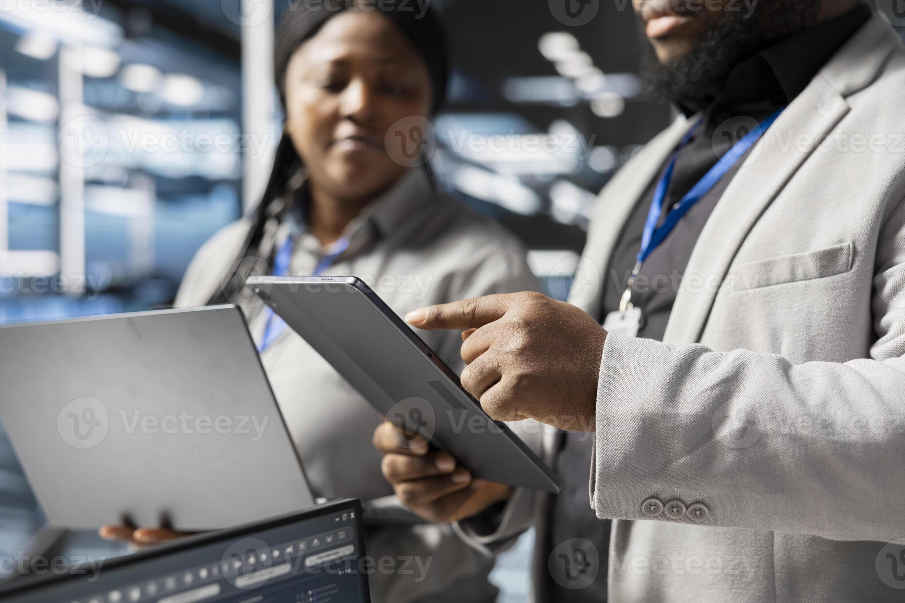 Data center coworkers working together to update servers tech, configuring infrastructure ...