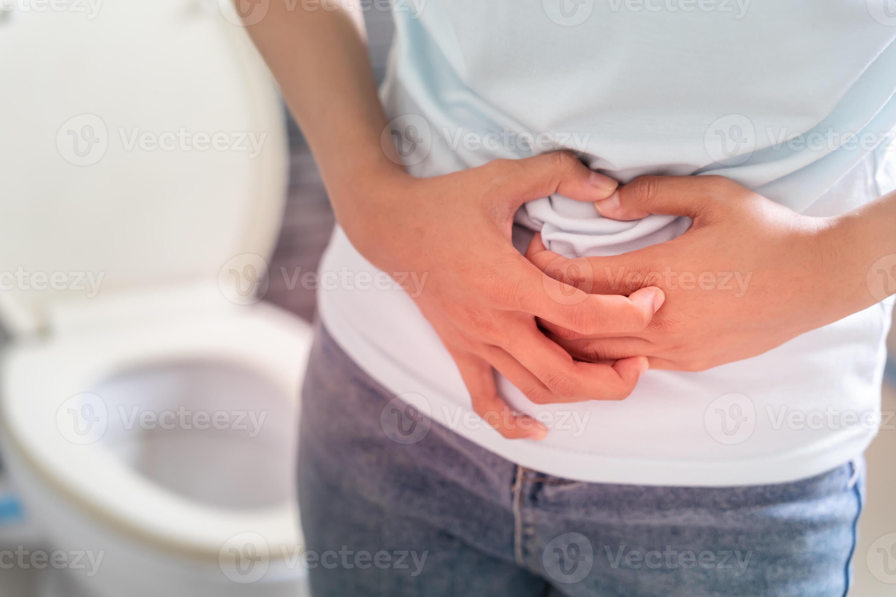 Constipation and diarrhea in bathroom. Hurt woman touch belly stomach ache painful. colon ...