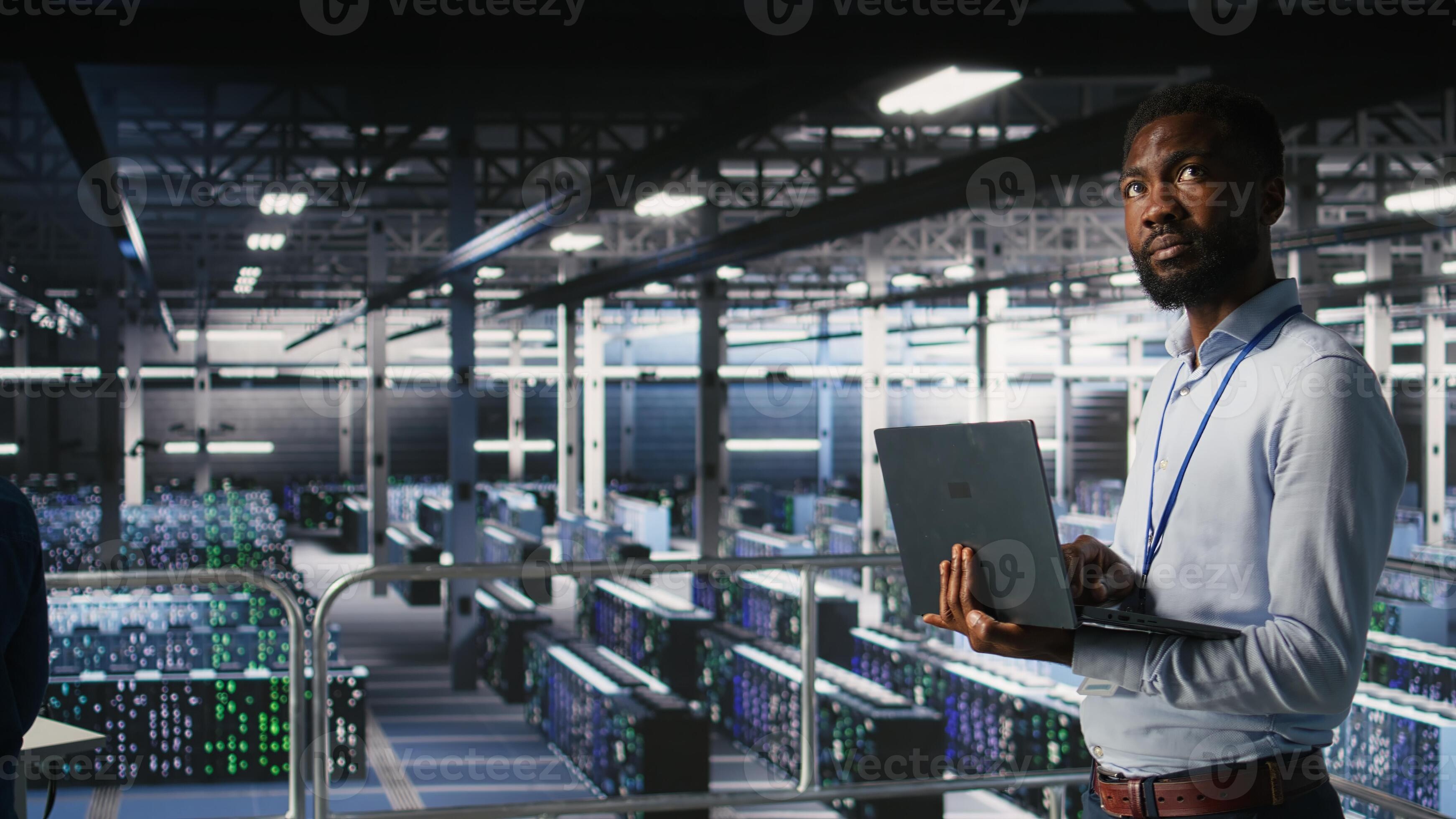 Engineers in data center using laptop to monitor neural network LLM visualization. Coworkers on ...