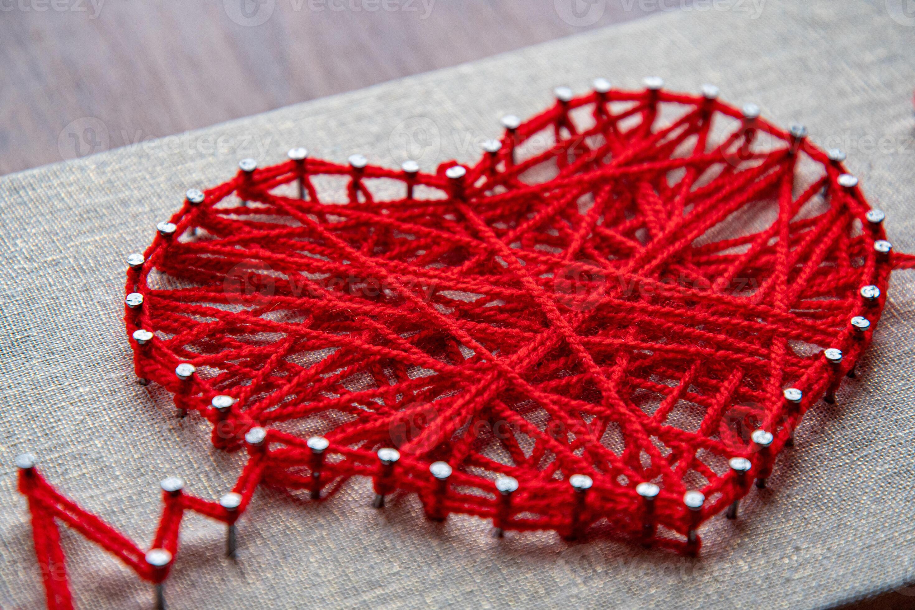 Heart shaped string art made with tangled yarn on metal nails on canvas background 67767277 ...