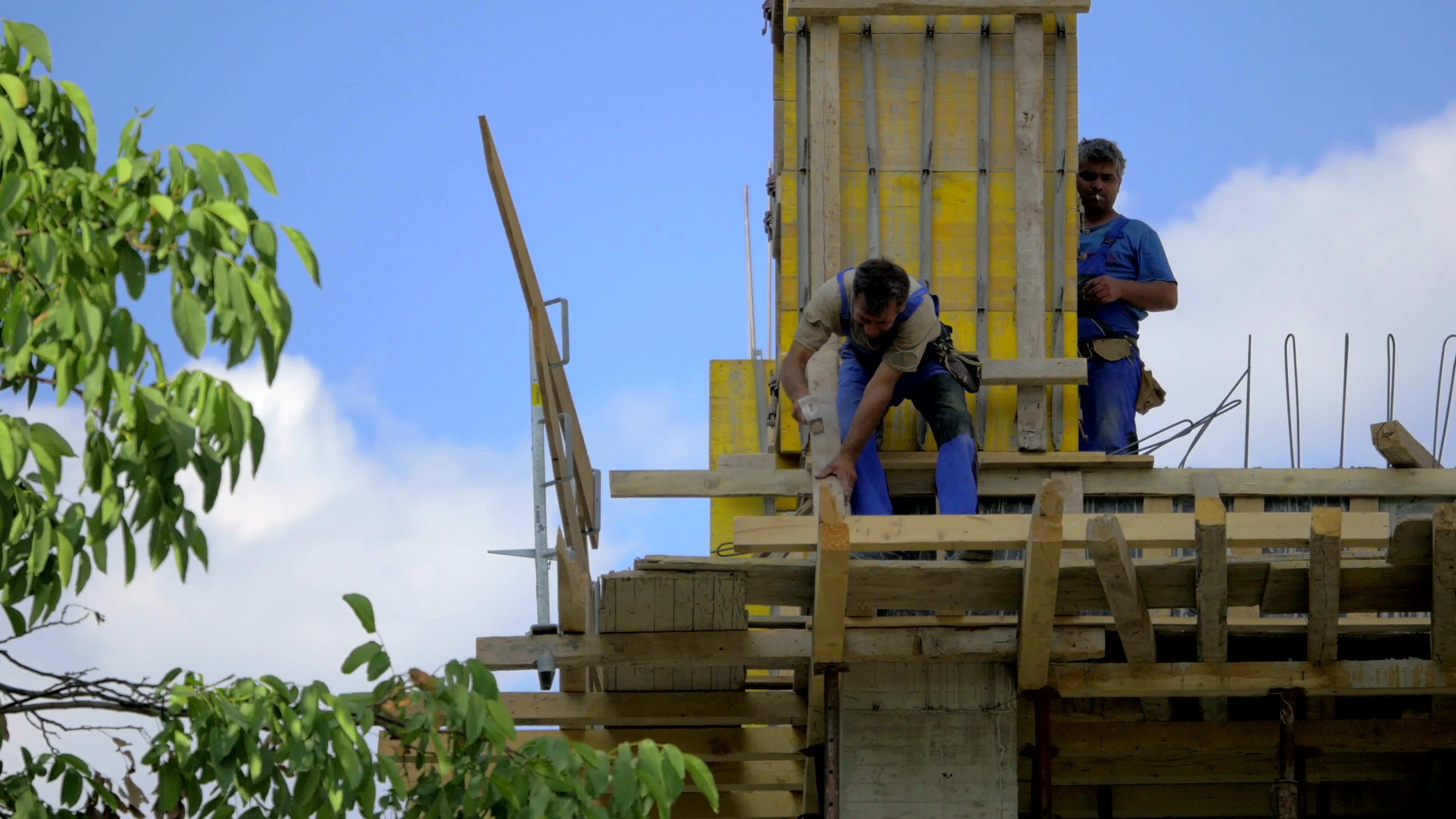 Construction worker hitting a nail with hammer 4K stock video 1614893 ...