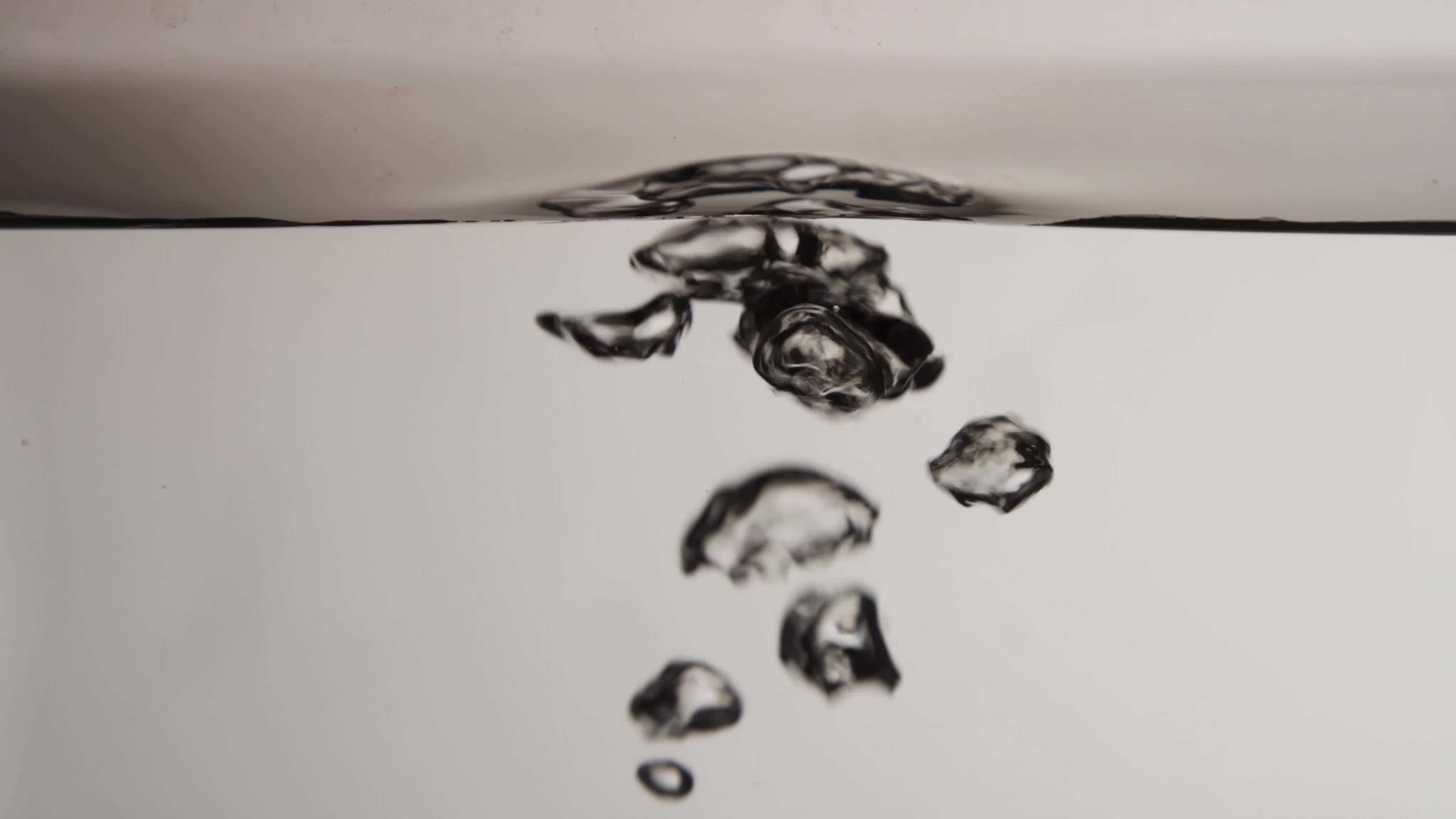 Extreme close up of aquarium and air bubbles exploding in the surface ...