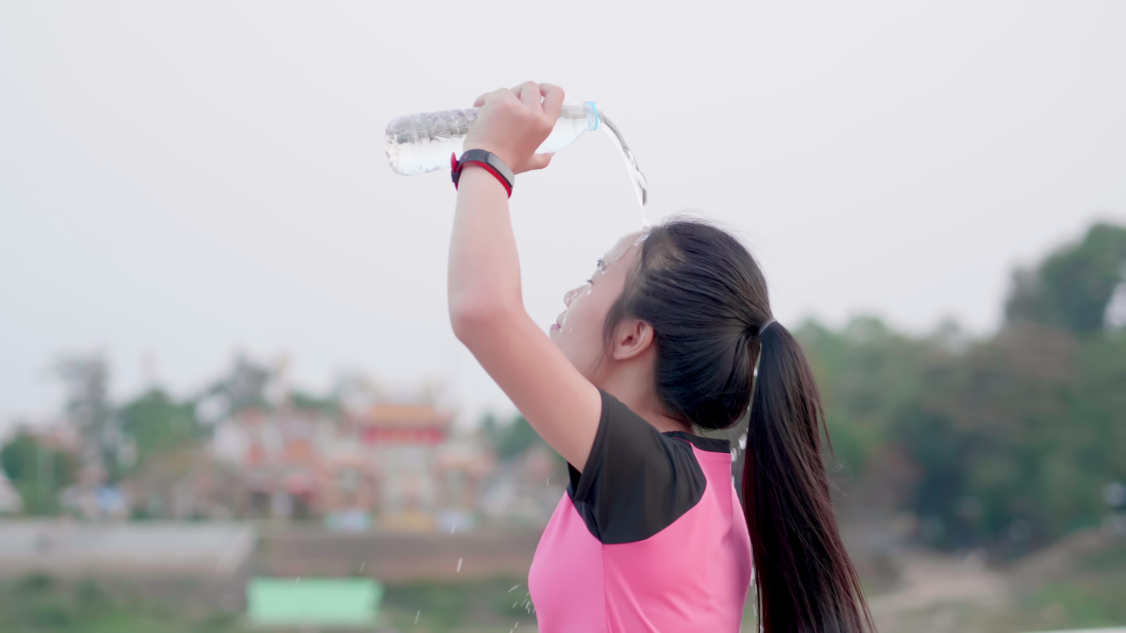 Young Asian Woman Pouring Water on Her Head to Refresh After a Workout 2224271 Stock Video at ...