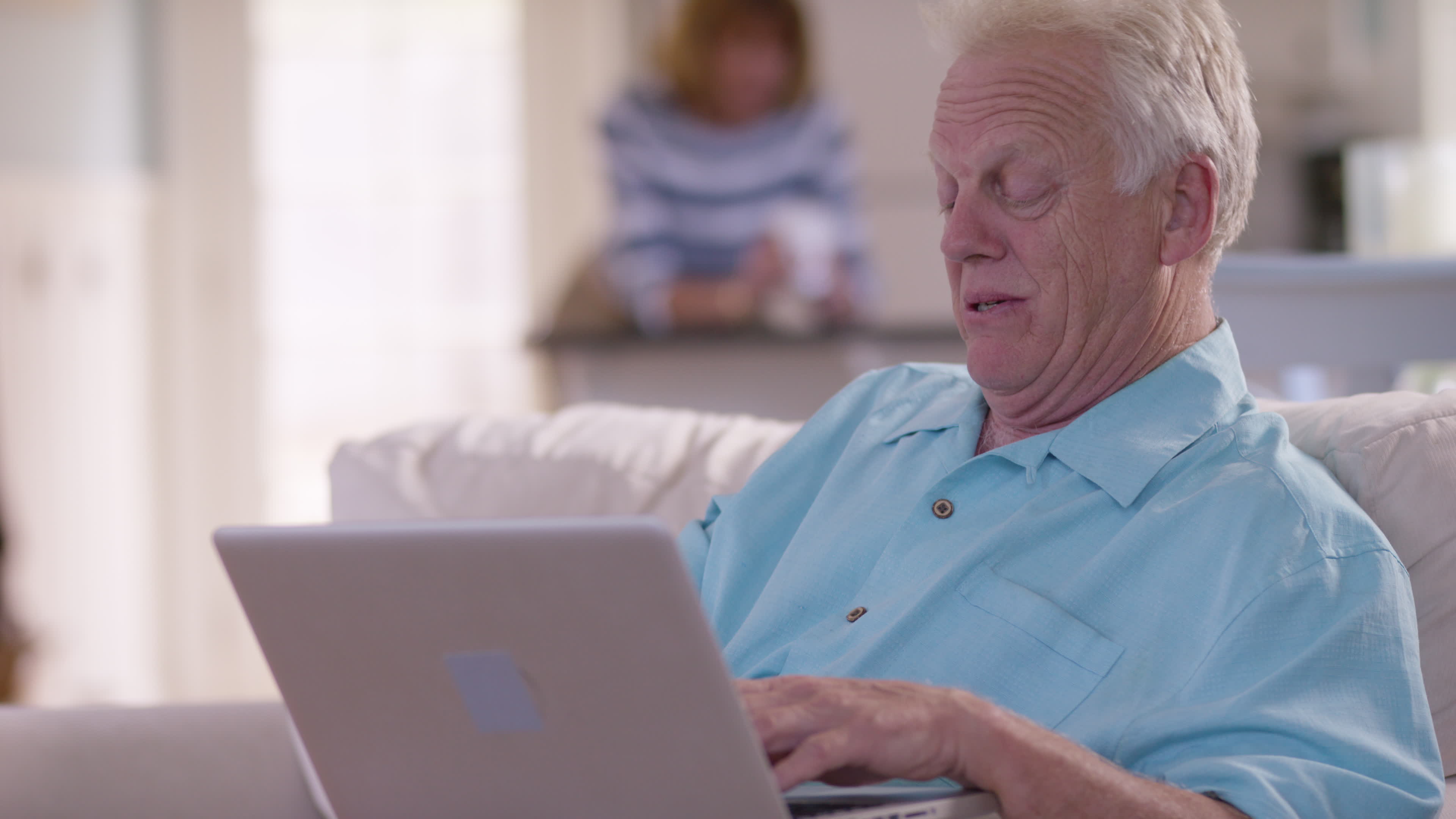 Senior man in living room using laptop computer 3165794 Stock Video at ...