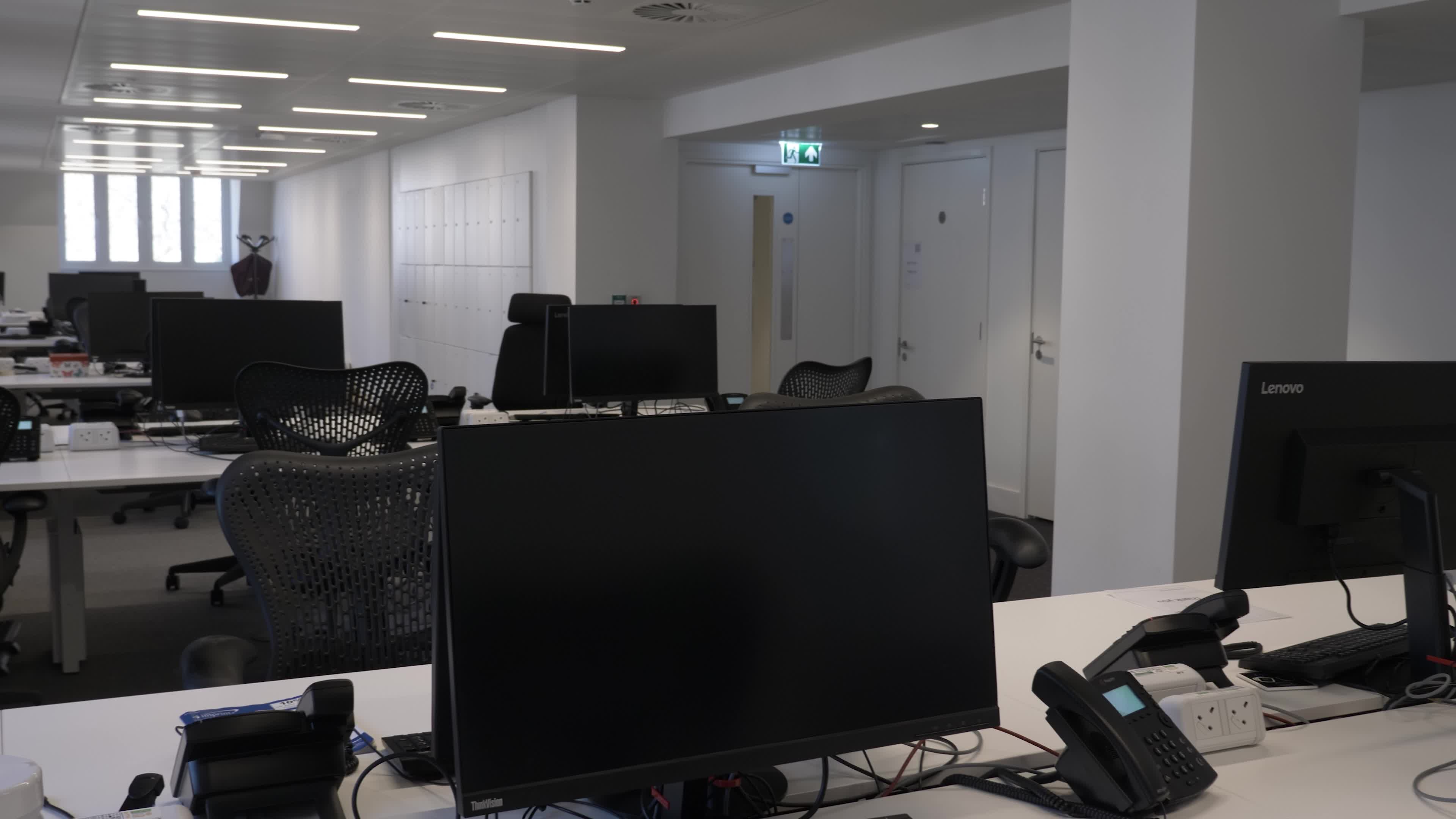 Eerie Empty Open Plan Office With Rows Of Multiple Workstations During ... Eerie Empty Open Plan Office With Rows Of Multiple Workstations During ...